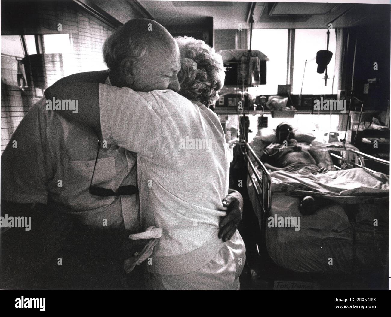 Tom Fox's parents, Bob and Doris, hug in his hospital room at Sacred ...