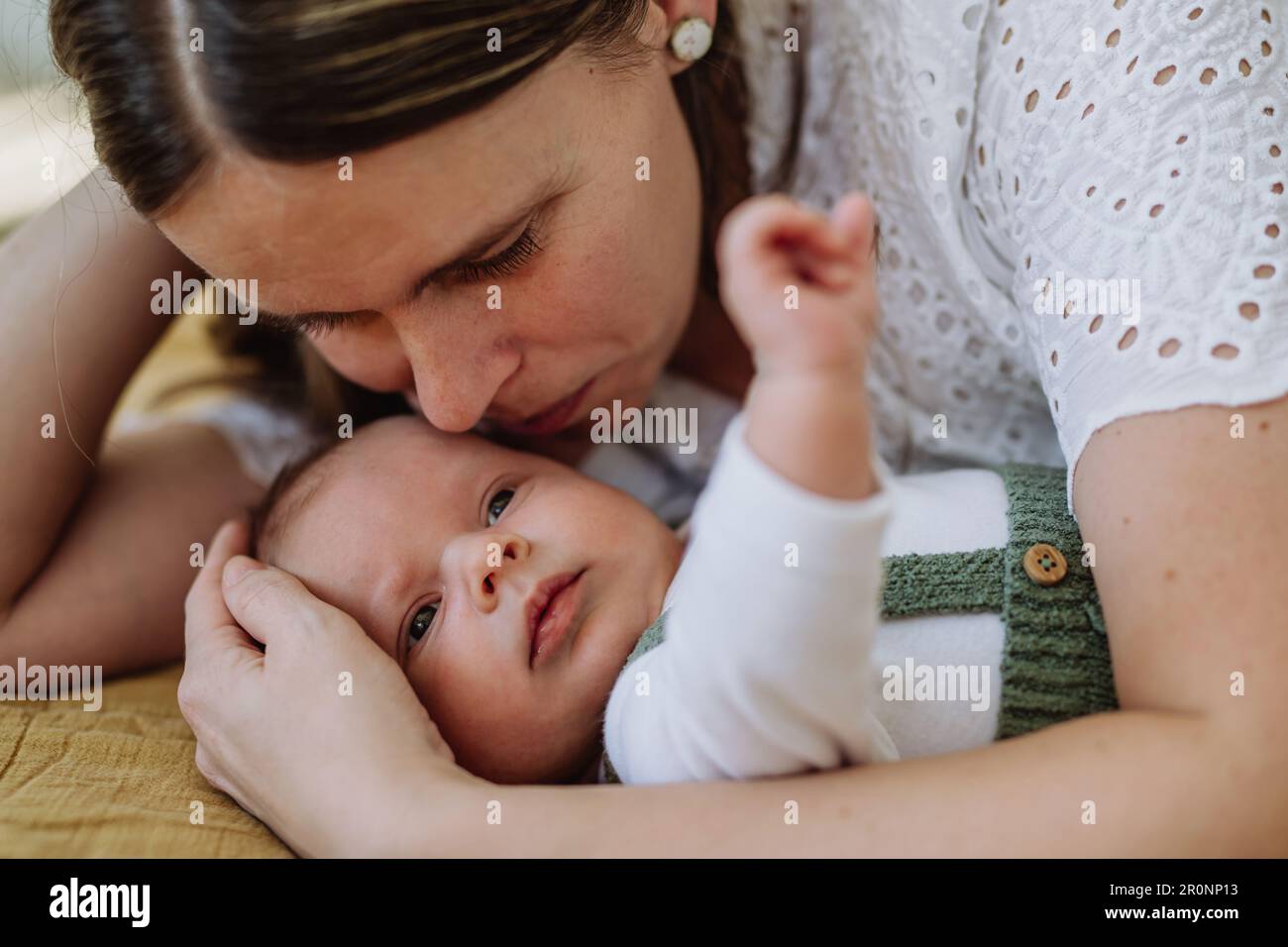 Affectionate mom cuddling newborn hi-res stock photography and images ...