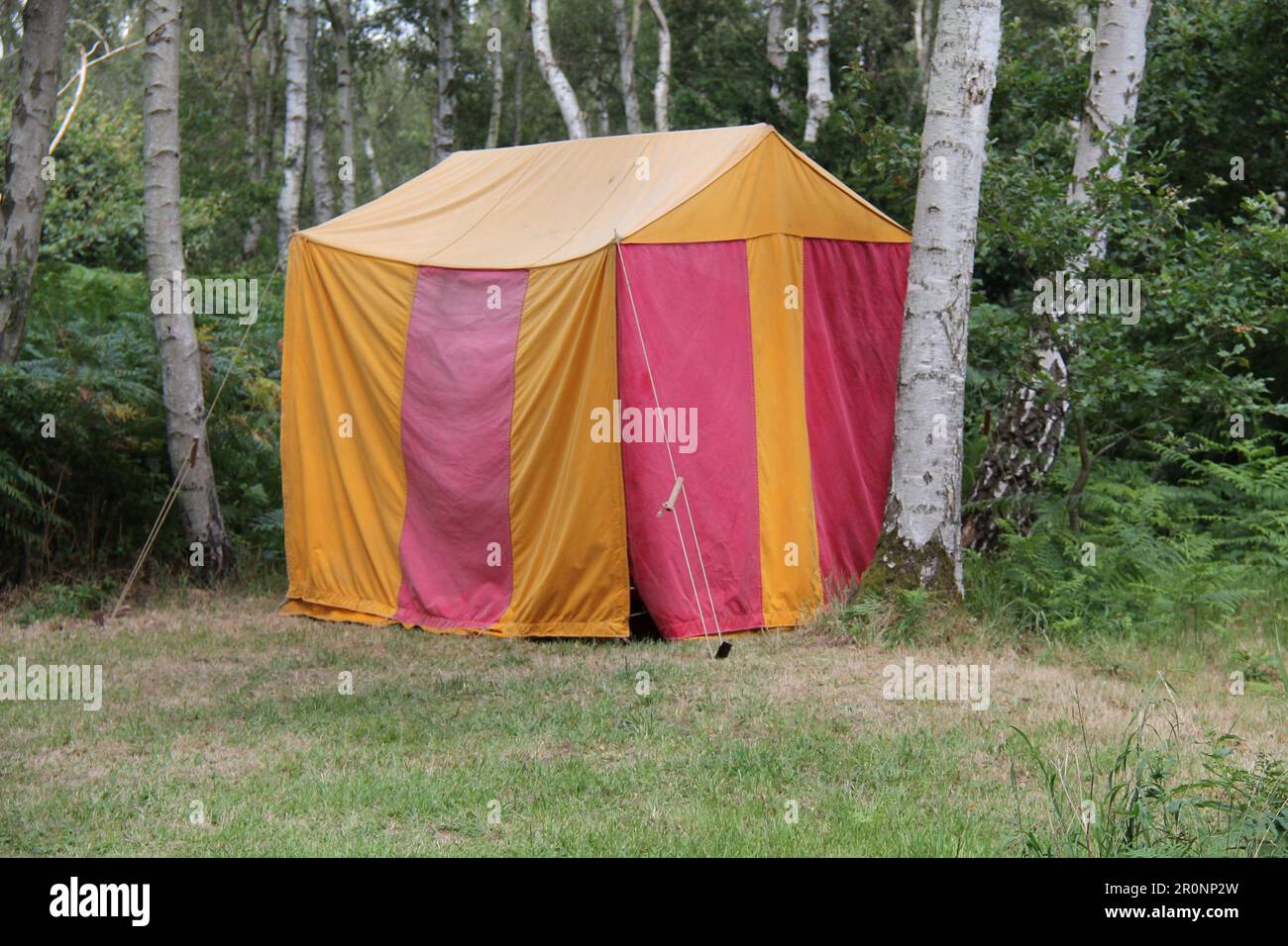 A Colourful Red and Yellow Tent in a Woodland Setting Stock Photo - Alamy