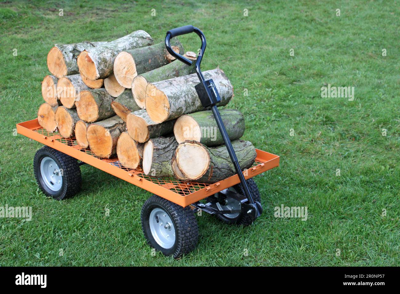 A Garden Trolley Piled High With Wooden Logs Stock Photo - Alamy