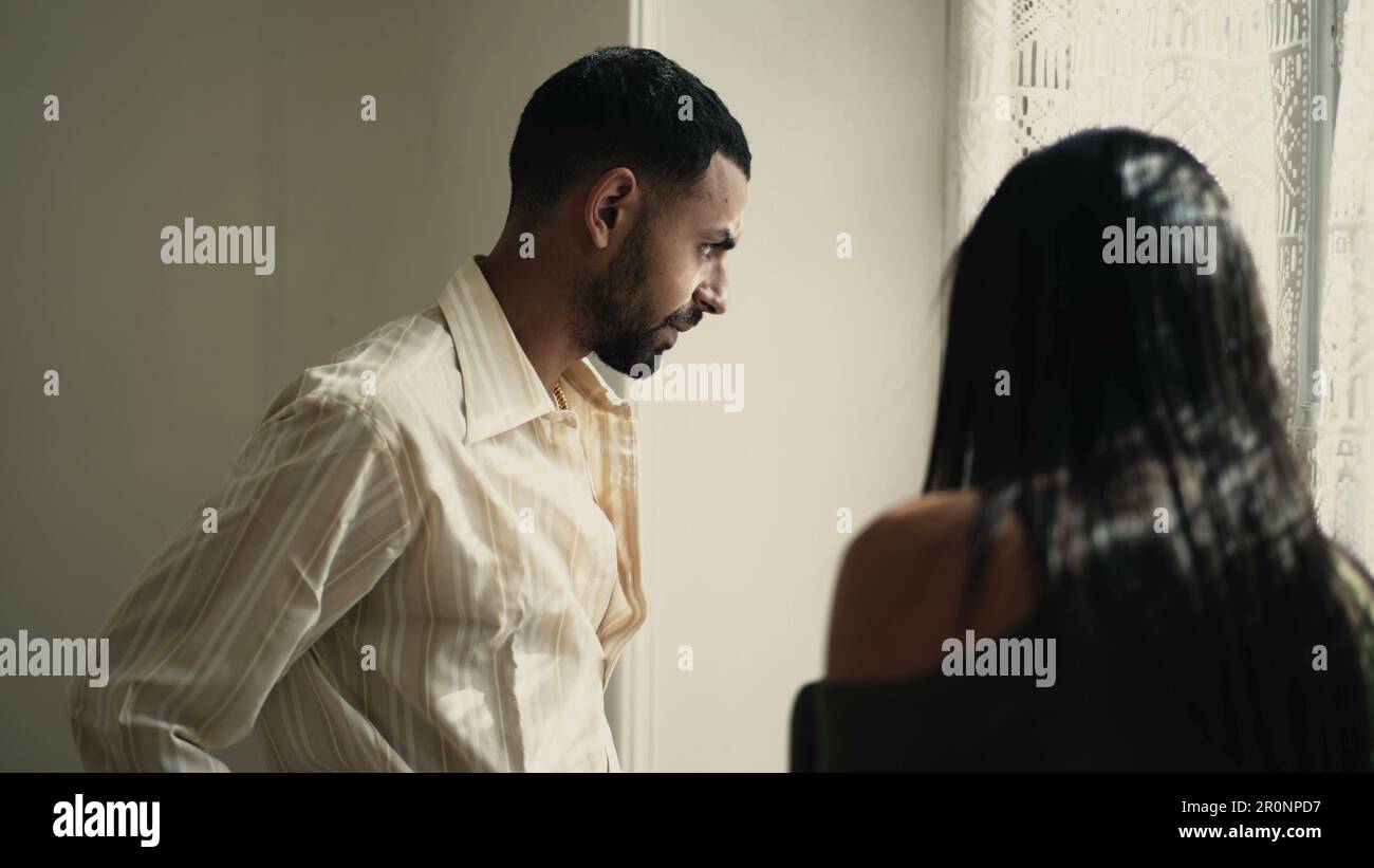 Angry man arguing with girlfriend by window at home. Male person ...