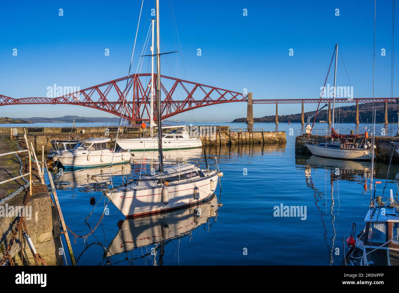Yachts moored in South Queensferry harbour with backdrop of Forth Rail ...