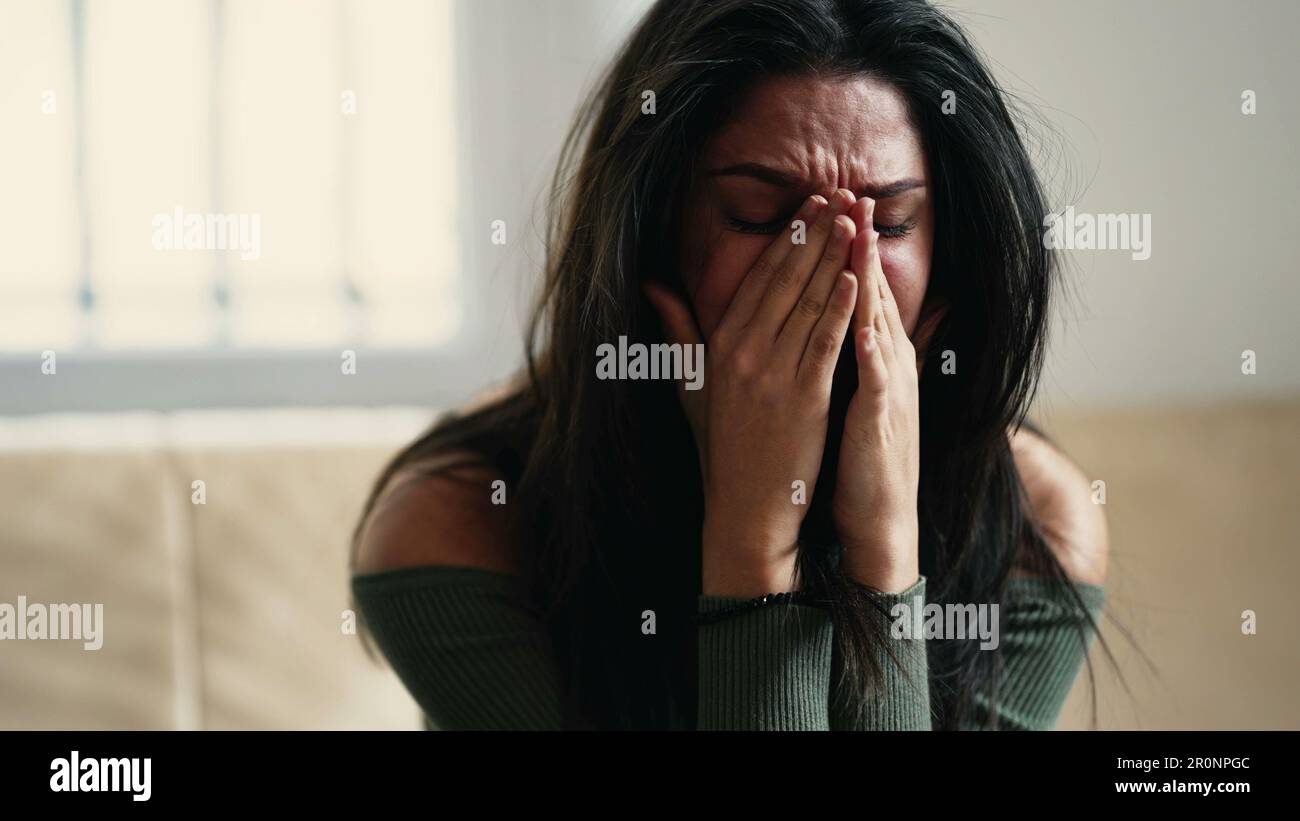 Distressed young woman overwhelmed with anxiety and sadness, feeling ...