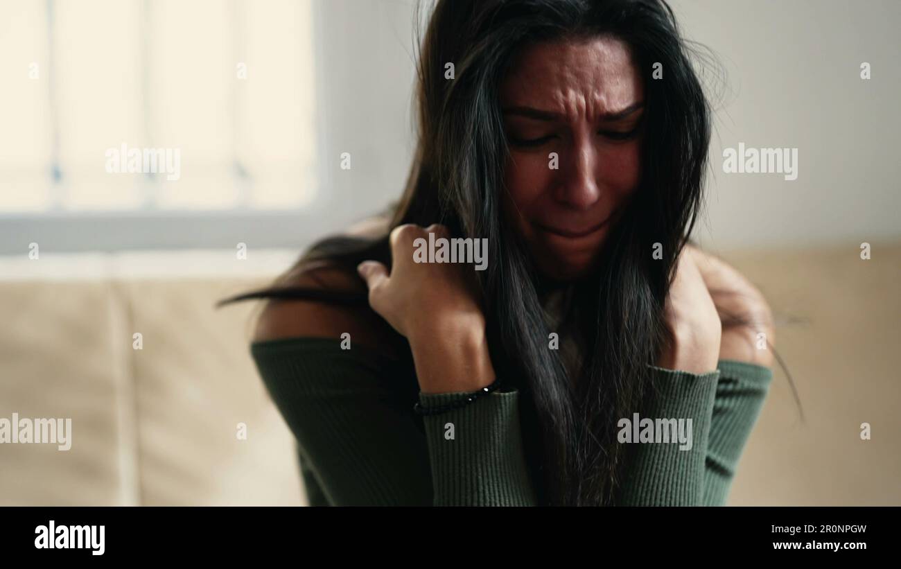 Distressed young woman overwhelmed with anxiety and sadness, feeling ...