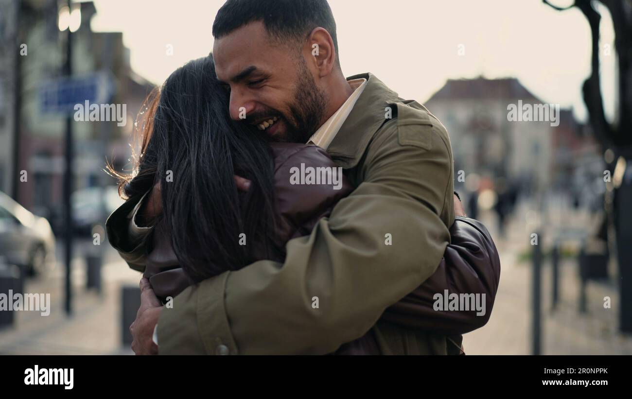 Happy genuine reunion Two people embracing in street feeling ecstatic ...