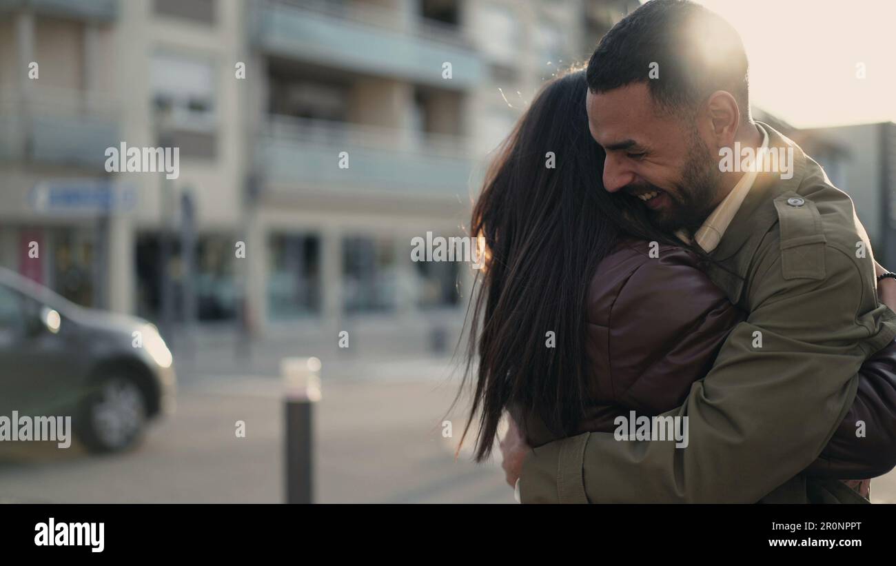 Happy genuine reunion Two people embracing in street feeling ecstatic ...