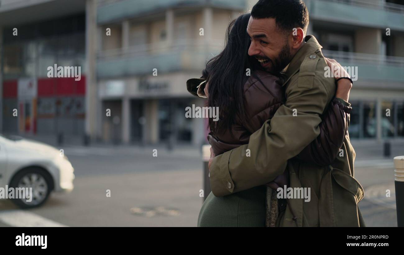 Happy genuine reunion Two people embracing in street feeling ecstatic ...