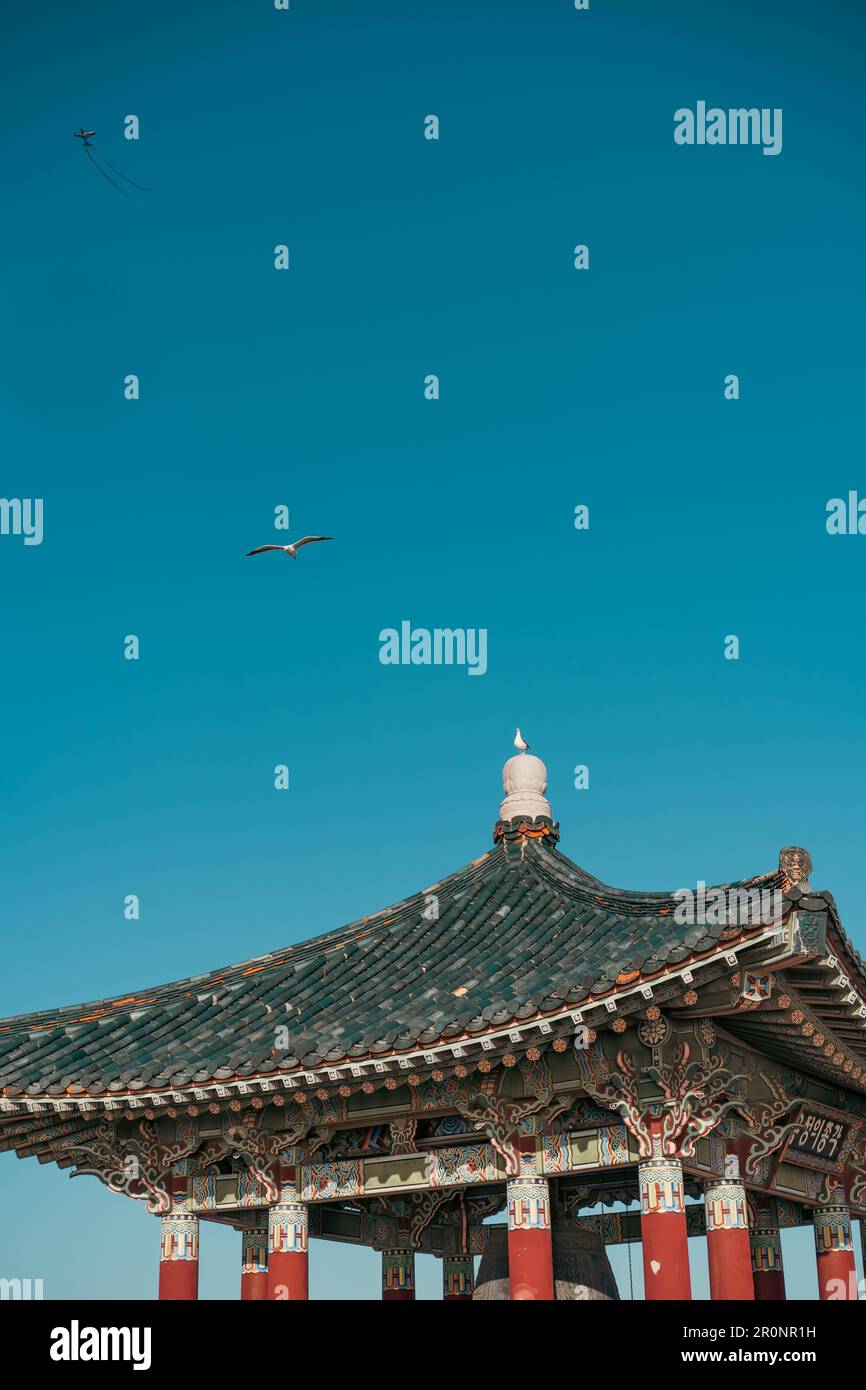 The majestic Korean Friendship Bell against a vivid blue sky, with ...