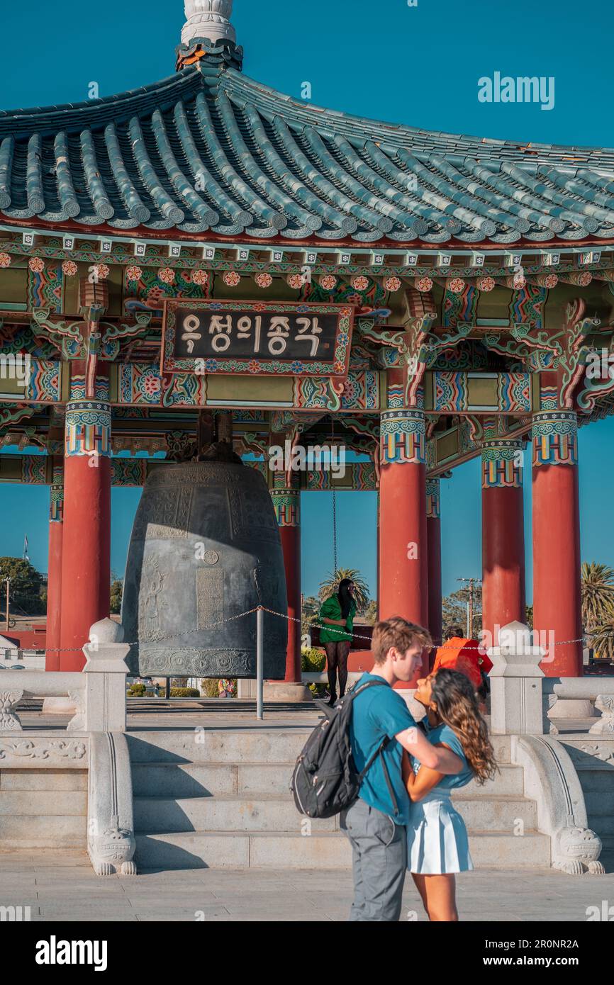 A loving young couple embracing each other in front of the Korean ...