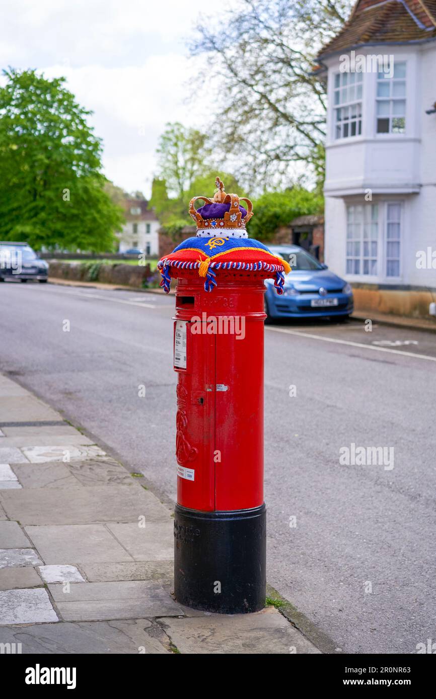 British Royal Mail red post box decorated with a knitted red white and ...