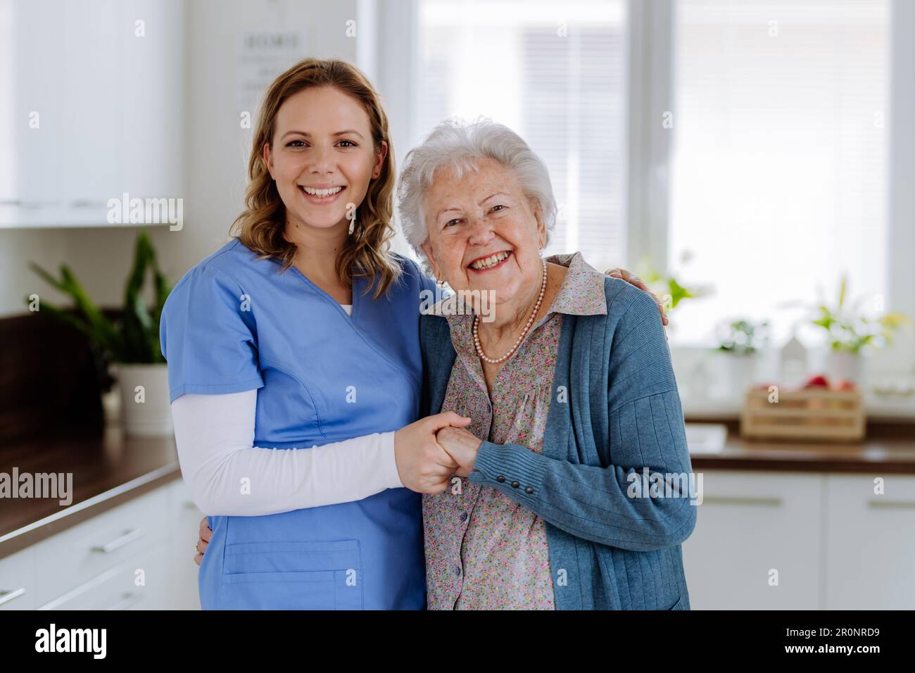 Young doctor hugging senior hi-res stock photography and images - Alamy