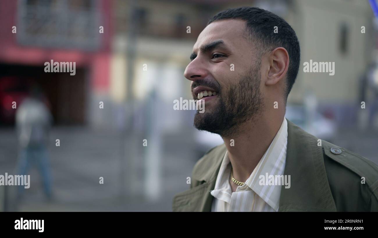 A content Arab man strolls down city. Tracking shot of a thoughtful ...