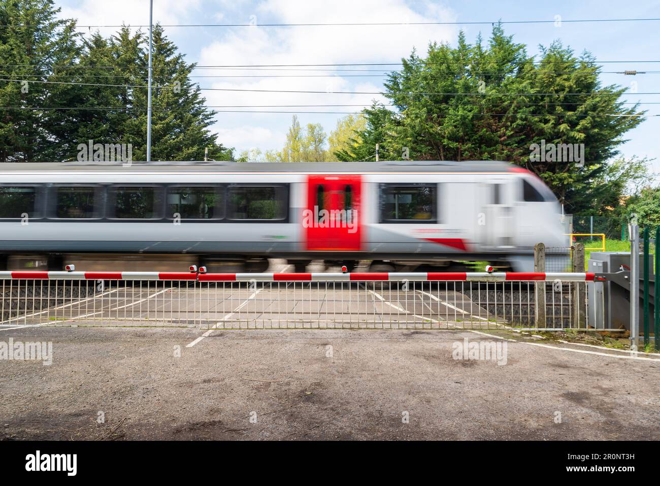 British Rail Class 720 Aventra train of Greater Anglia passing at speed over Church Lane ...
