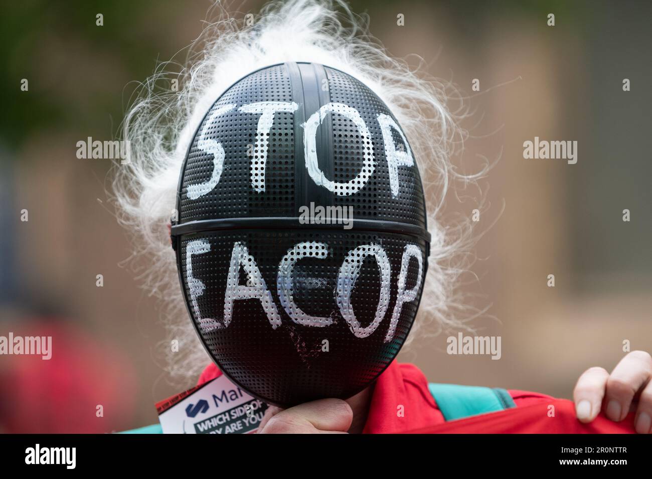 London, UK. 9 May, 2023. An environmental activist wears a 'Stop EACOP ...