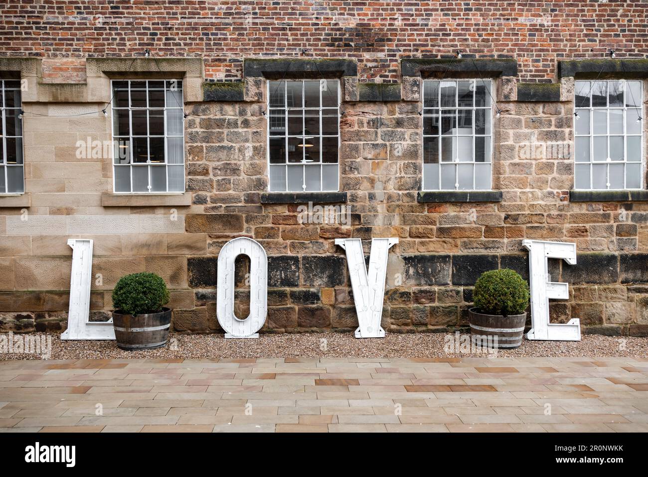 LOVE wooden letters outdoors in beautiful romantic courtyard with stone ...