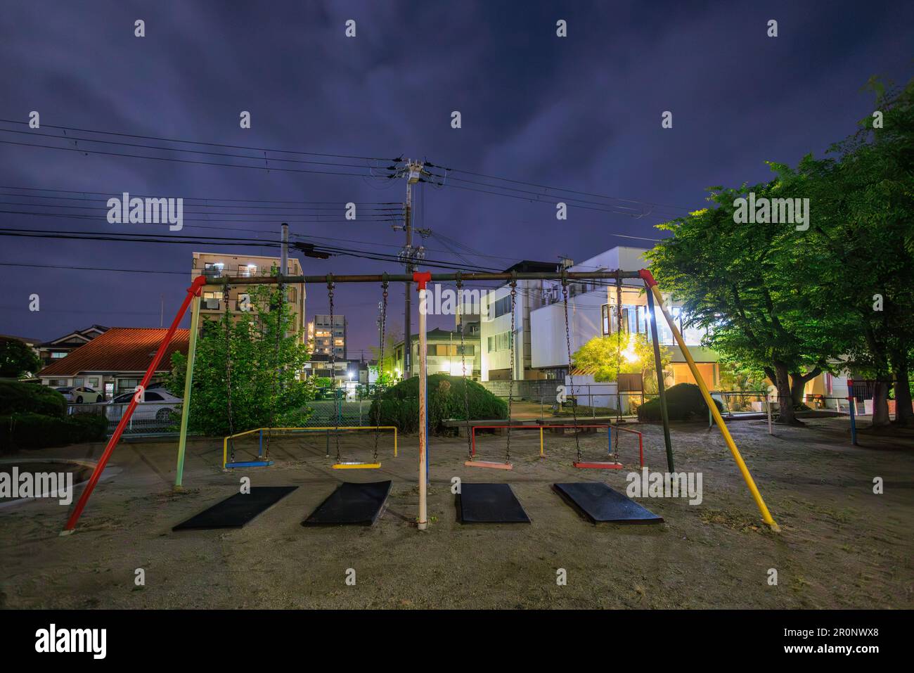 Empty swings in children's playground in quiet neighborhood park at ...