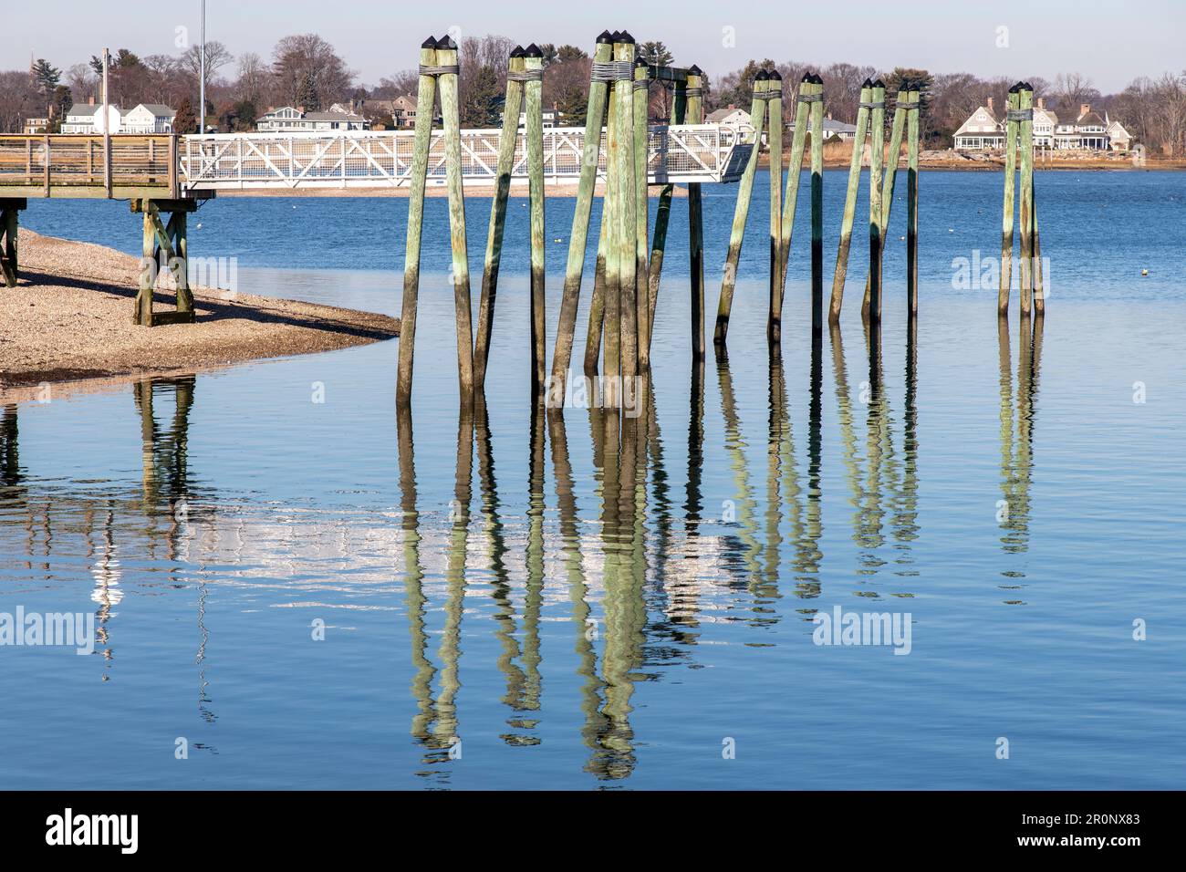 View over the waters of Greenwich Cove with a pier and long row of ...