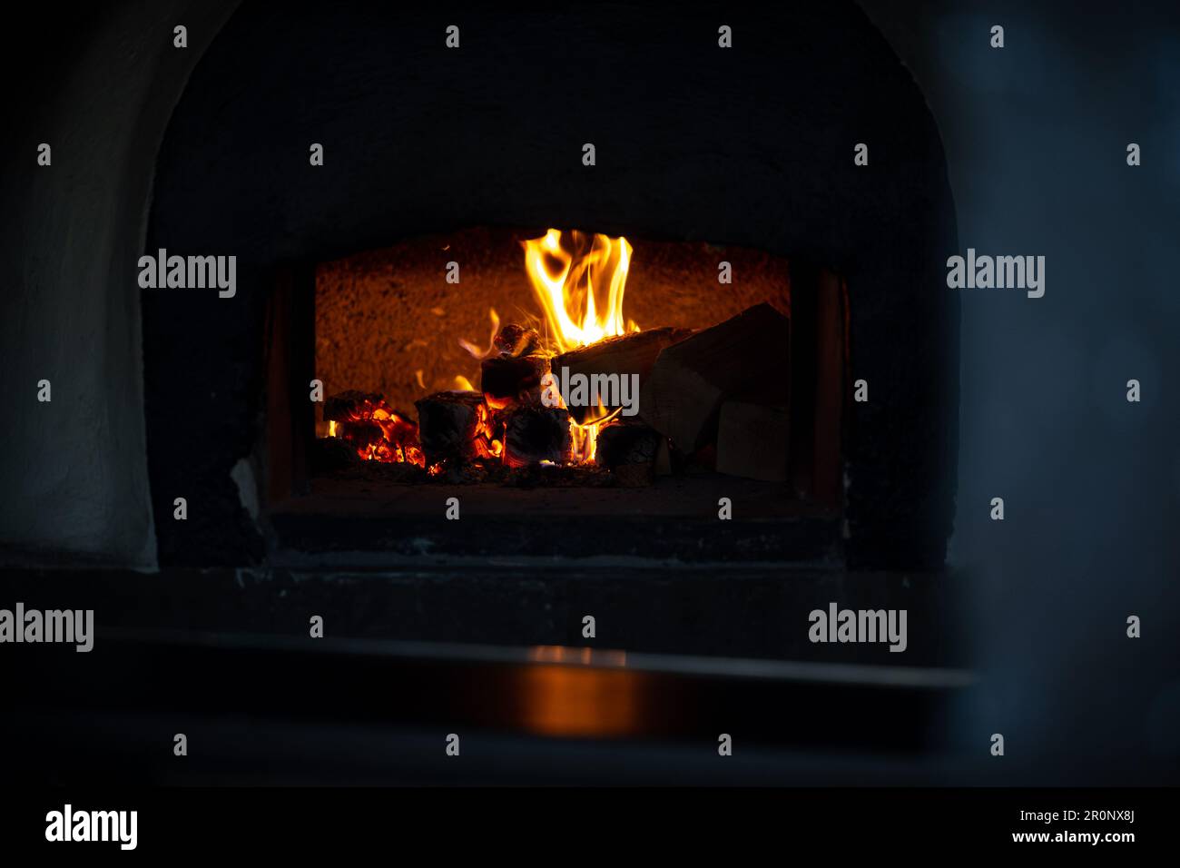 Pizza oven flames and fire as longs burn ready to cook fresh pizzas ...