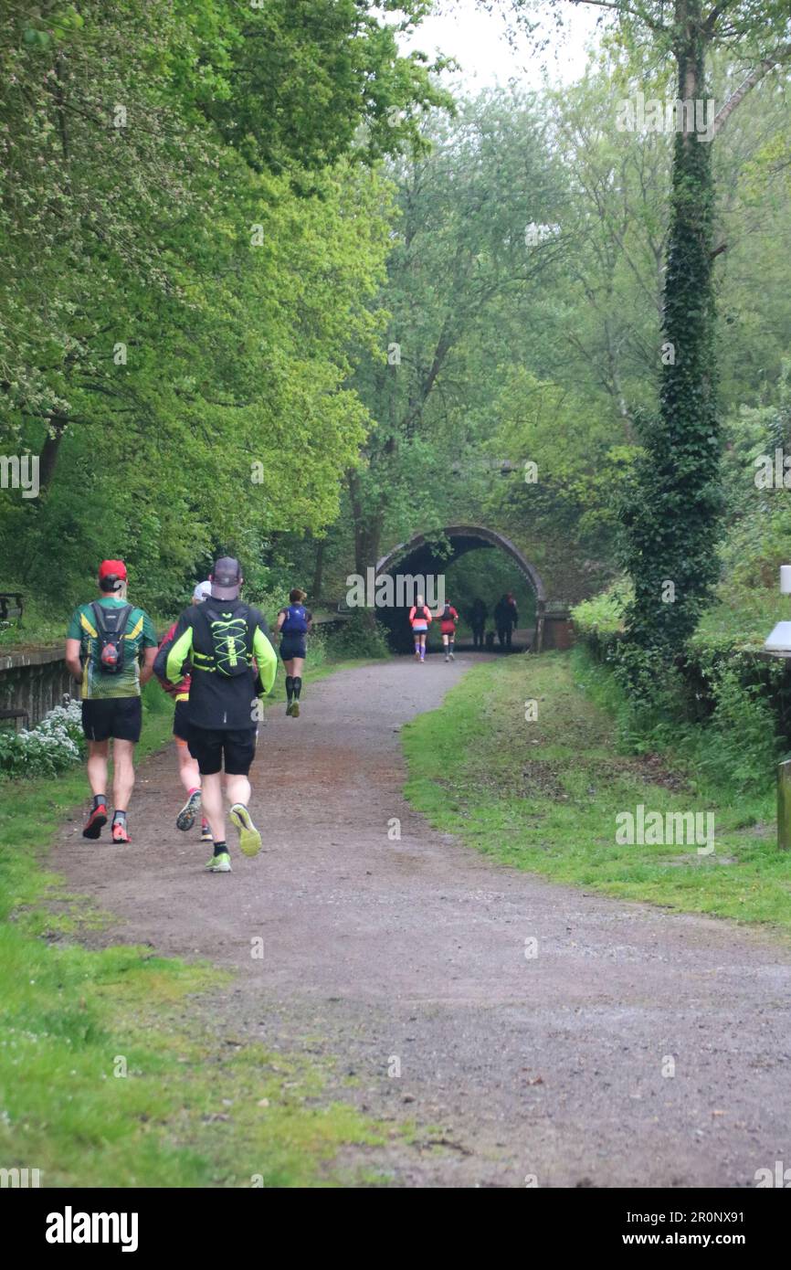 group of runners on a track competing in an Ultra long distance race ...