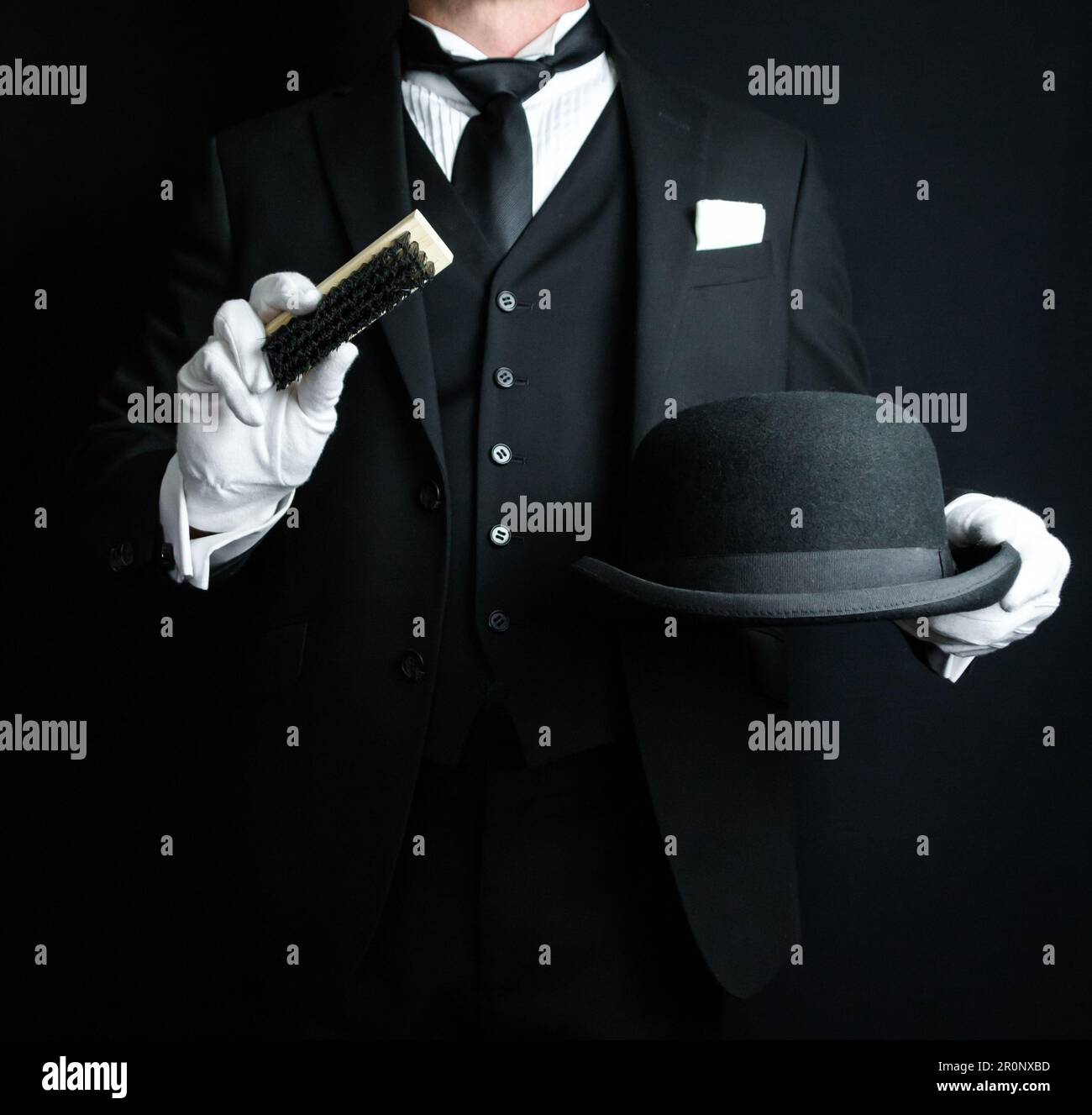 Portrait of Butler in Dark Formal Suit and White Gloves Brushing a ...