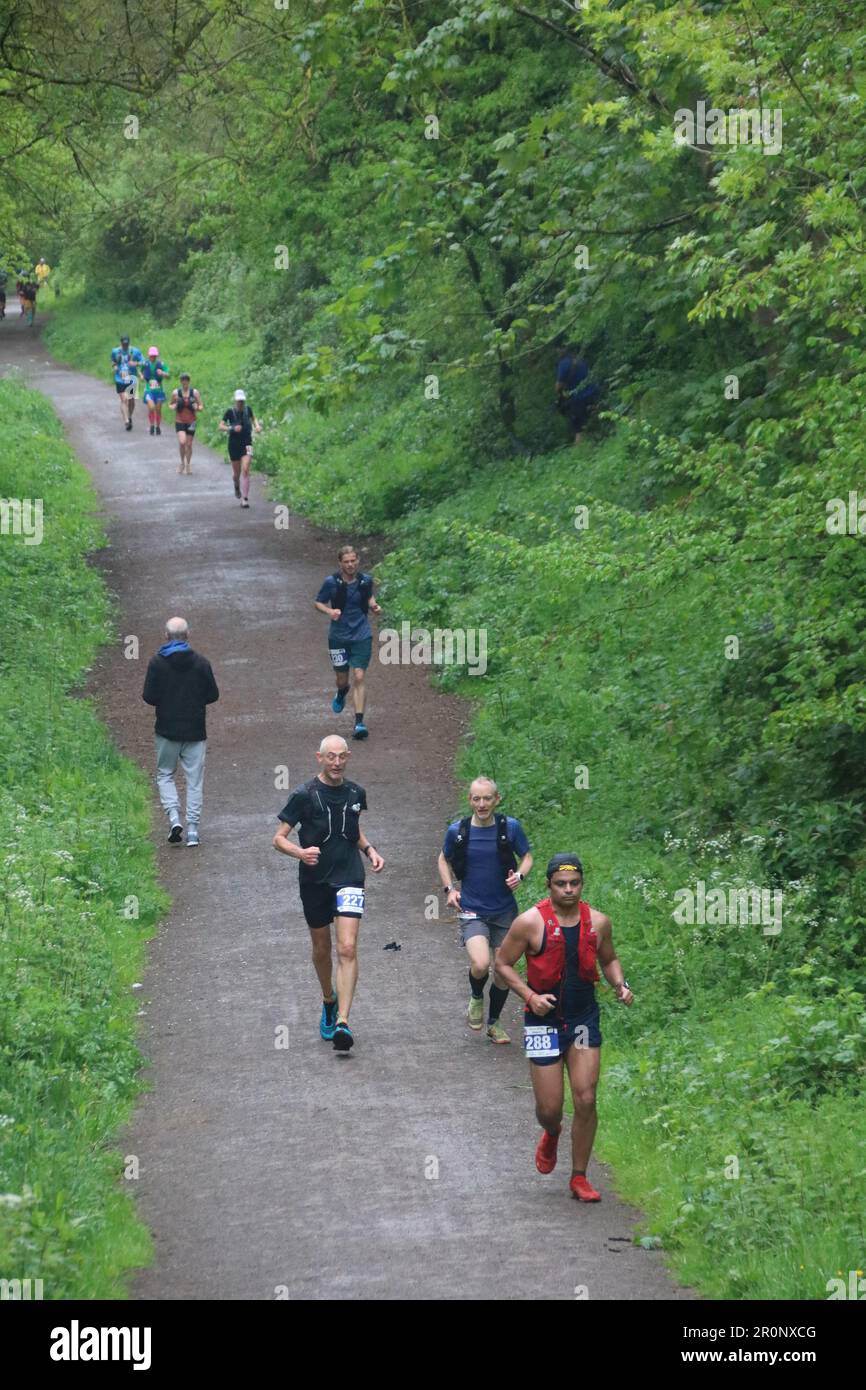 large group of runners on an old railway track competing in an Ultra ...