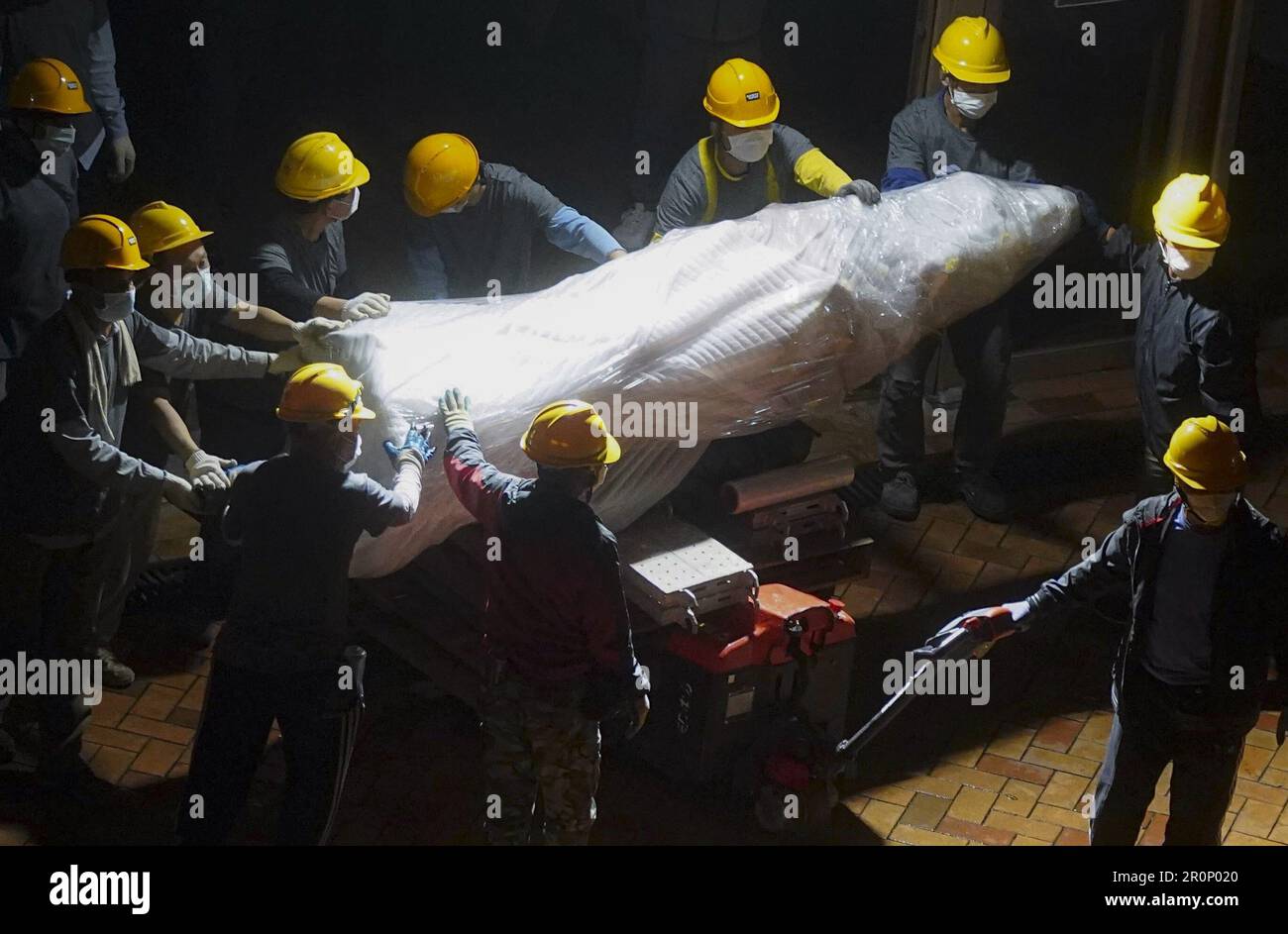 Workers remove a part of "Pillar of Shame" by Danish sculptor Jens ...