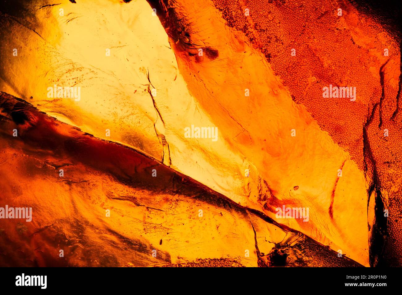 dark rough amber with inclusion. macro detail texture background. close ...