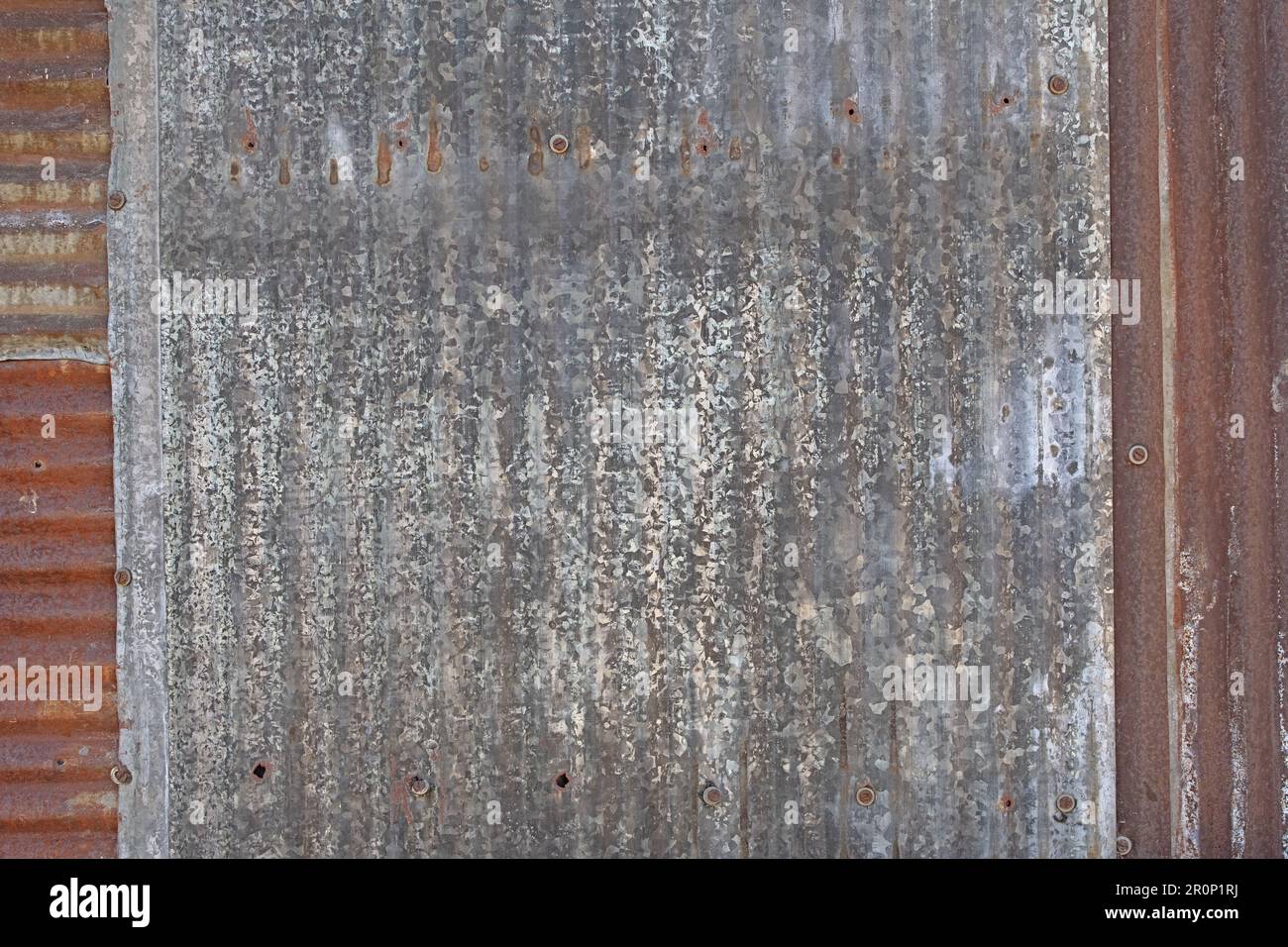 A view of old rusty sheet metal surface with corrugated texture, as a ...