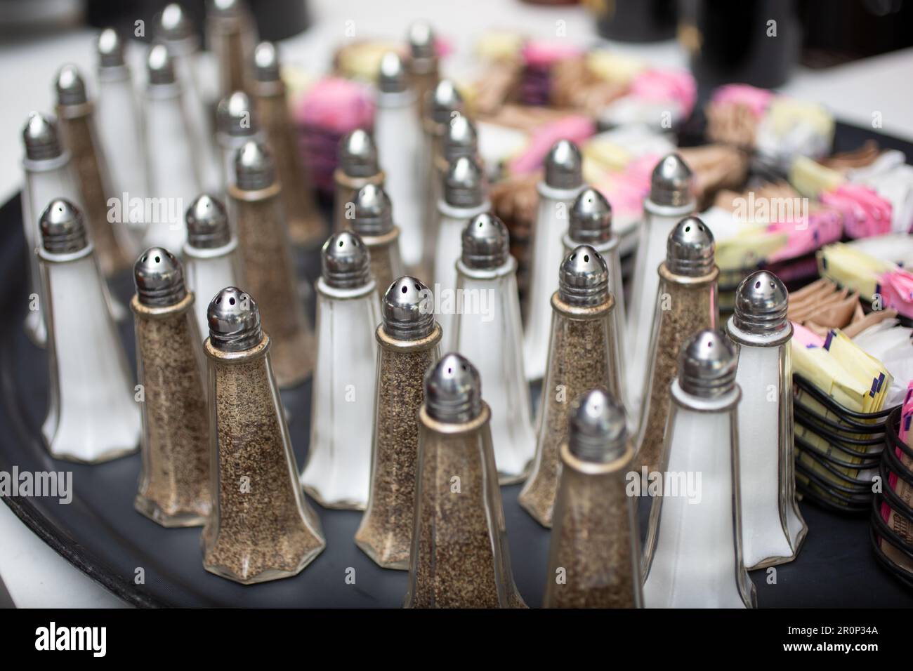 A view of several salt and pepper dispensers, seen during prep of a ...