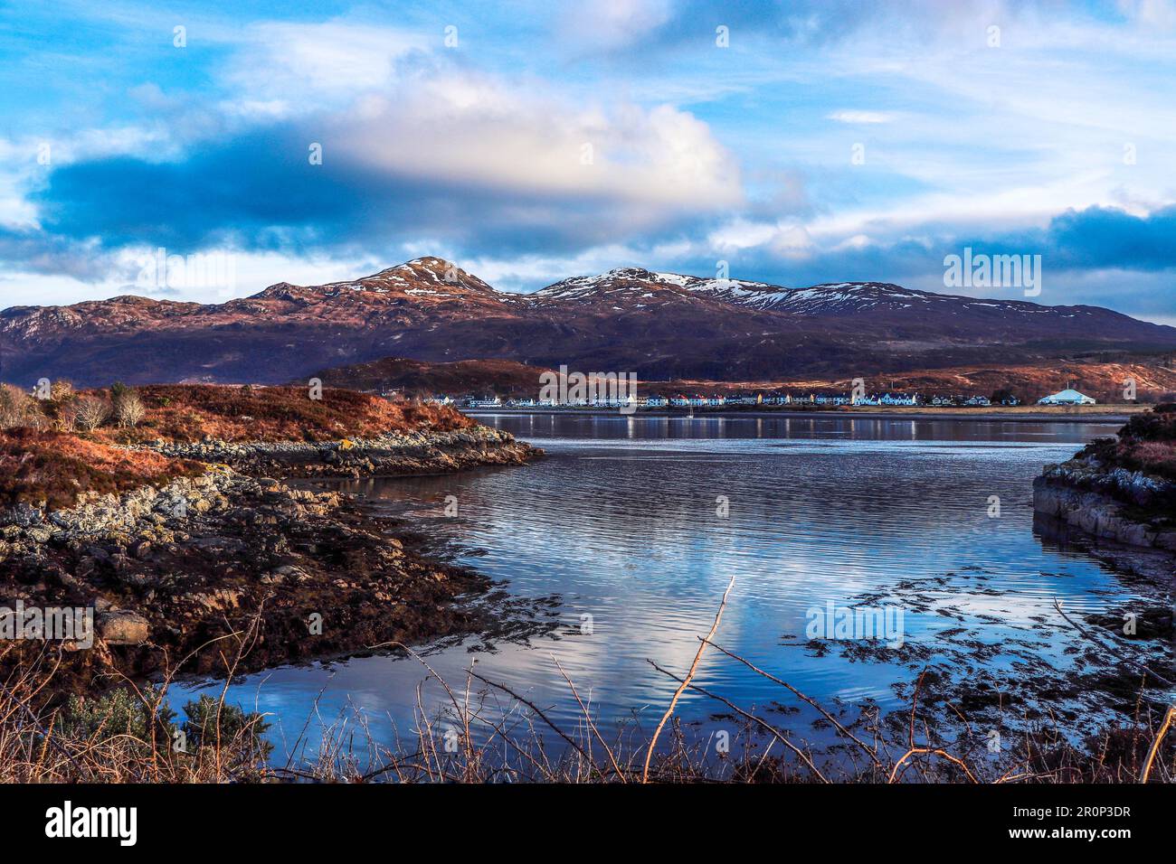 An aerial view of tranquil blue water and snowy mountains in Kyle of ...