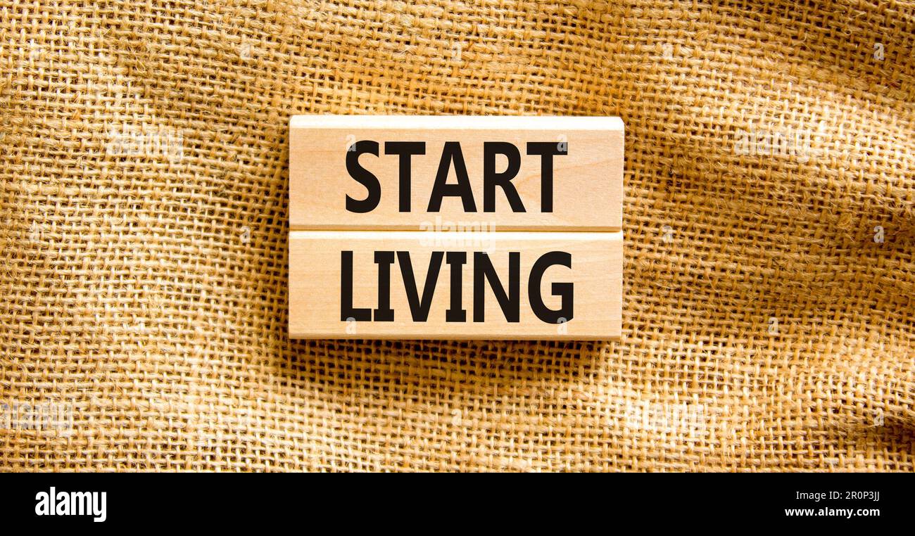 Start living symbol. Concept words Start living on beautiful wooden ...