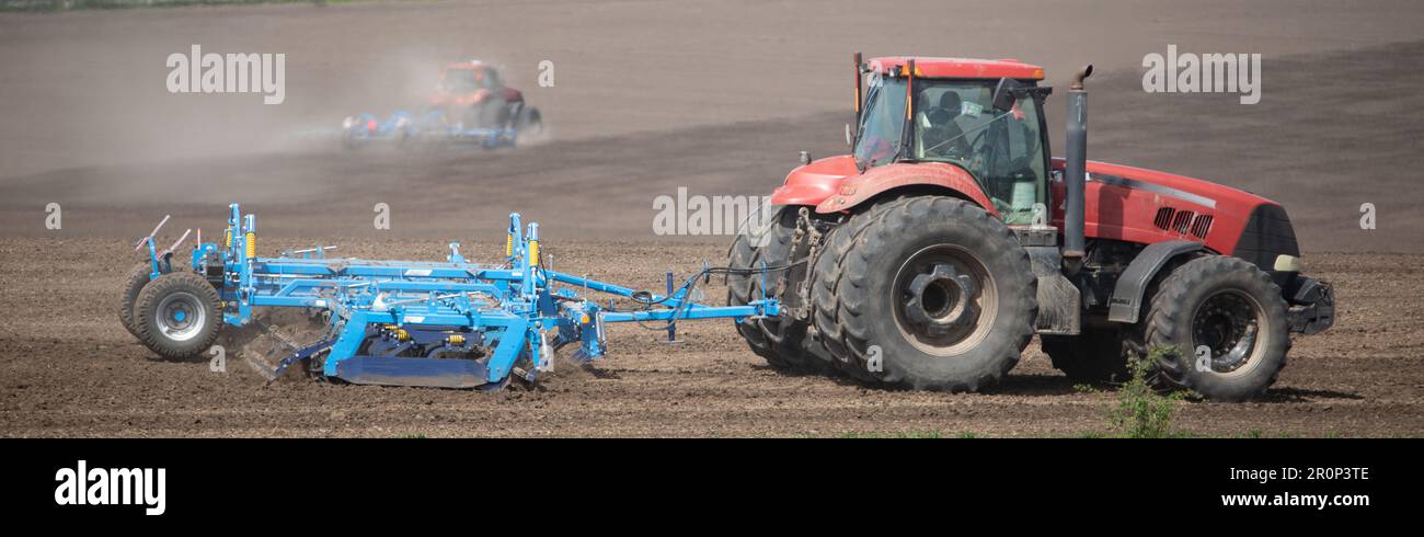 Watch as a heavy-duty tractor cultivator moves across the field ...