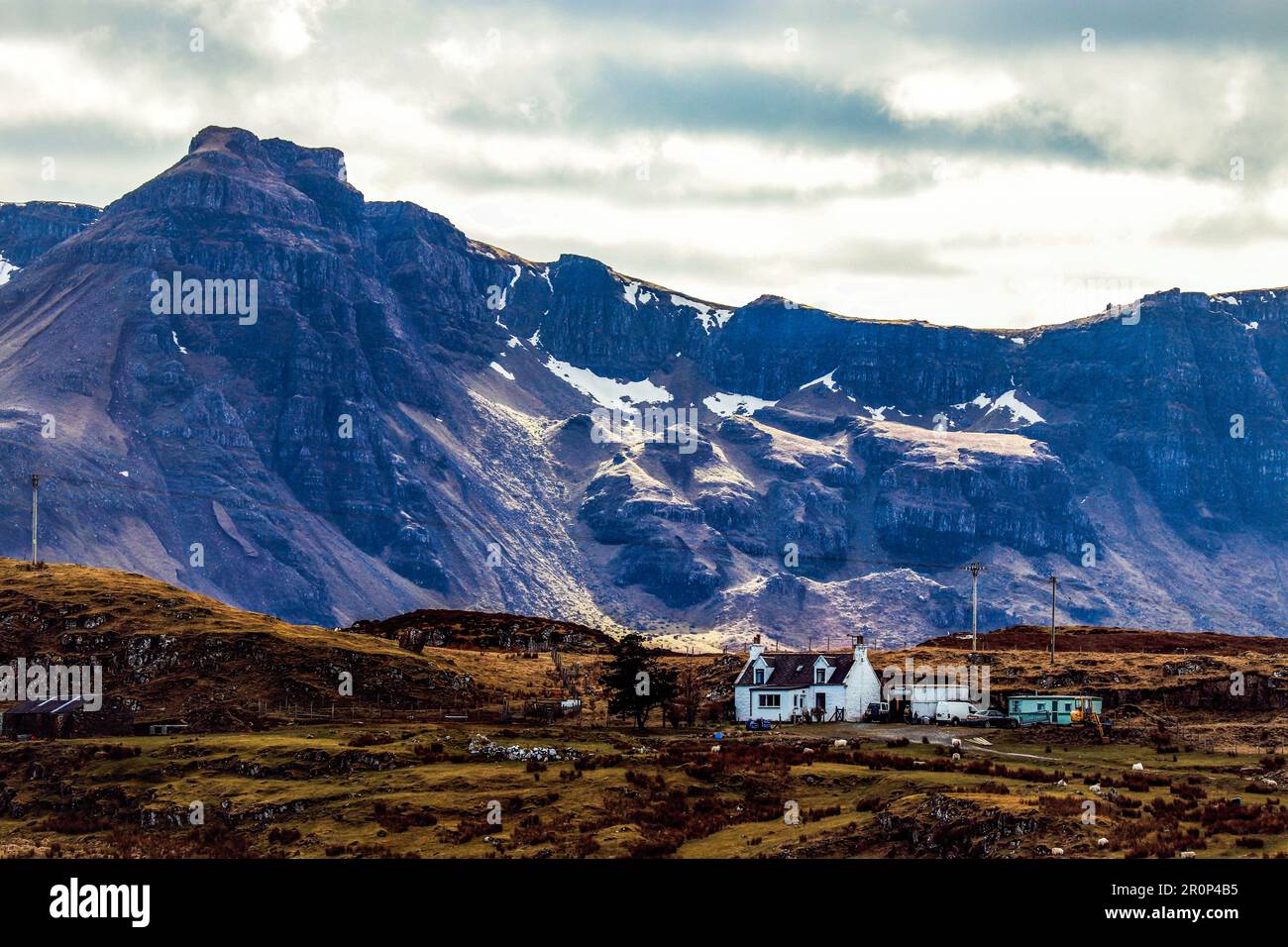 An aerial view of a small building located near mountains in Isle of ...