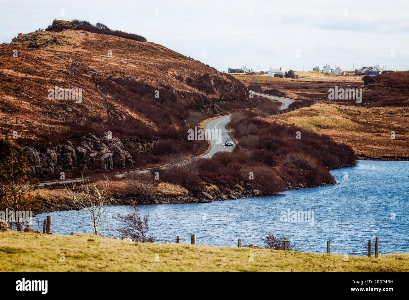 A scenic winding road surrounded by majestic rolling hills and tranquil ...
