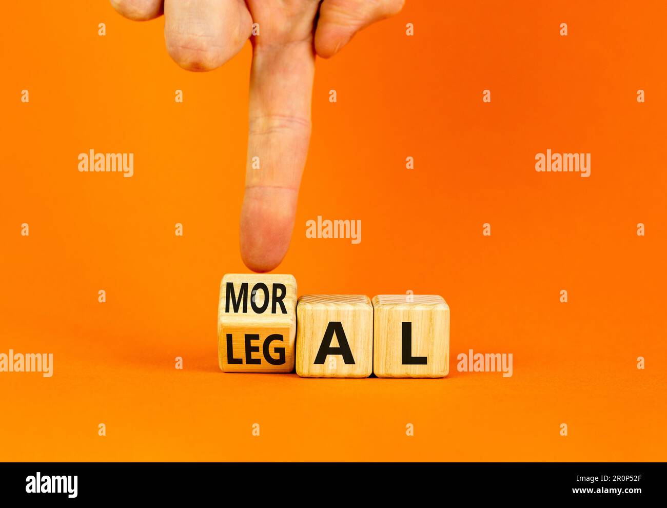 Legal or moral symbol. Businessman turns wooden cubes and changes the ...