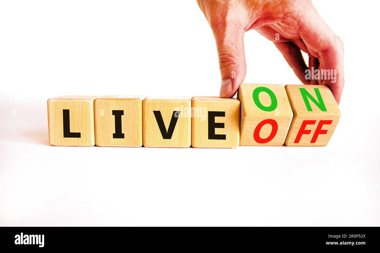 Live on or off symbol. Businessman turns wooden cubes and changes word ...