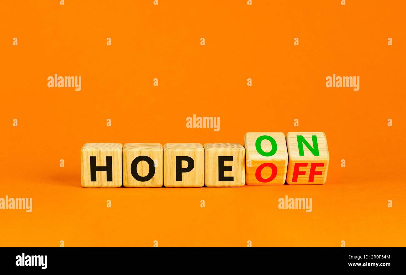 Hope on or off symbol. Businessman turns wooden cubes and changes word ...