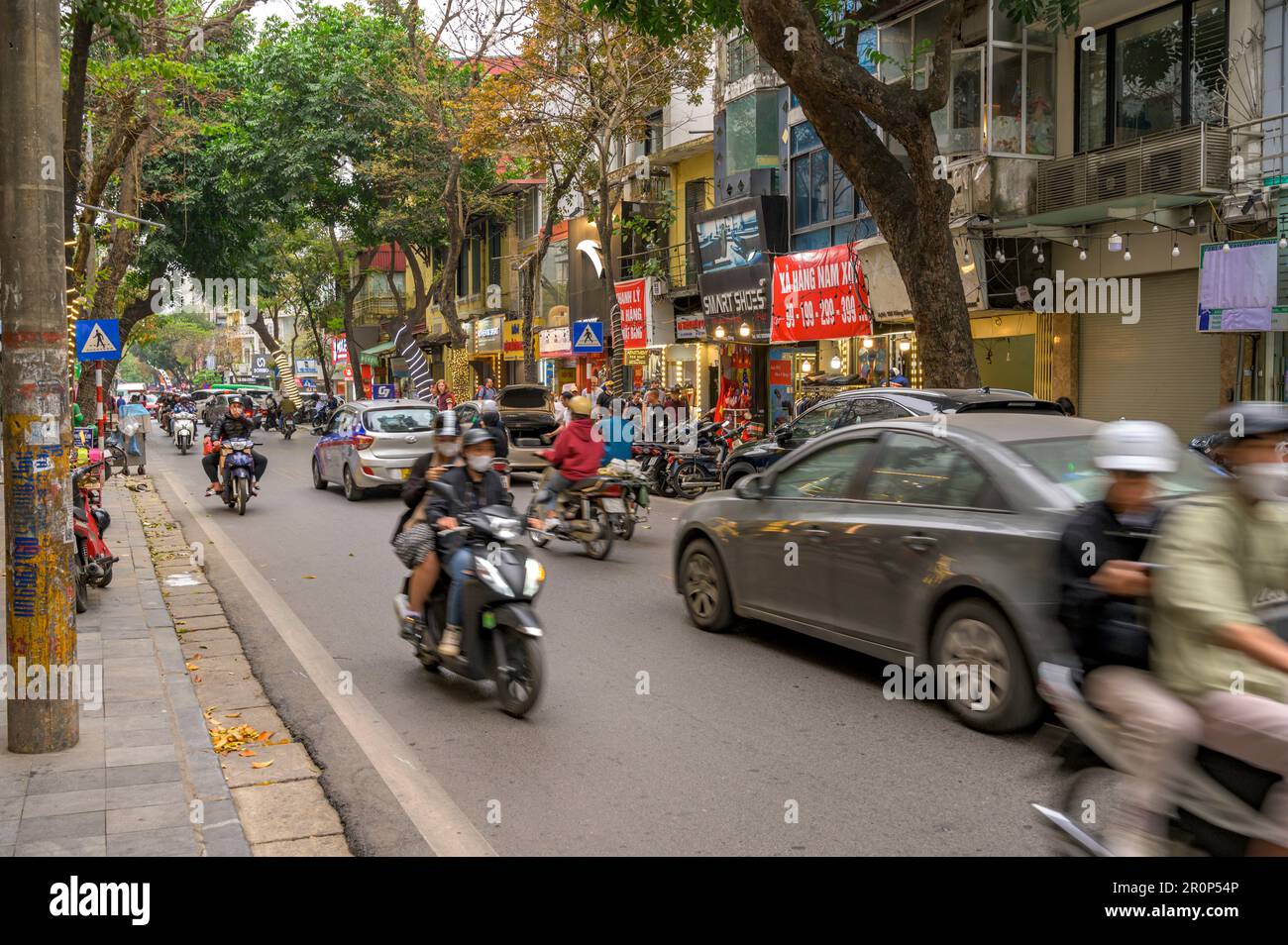 Busy street scene with different modes of transport in the old town of ...