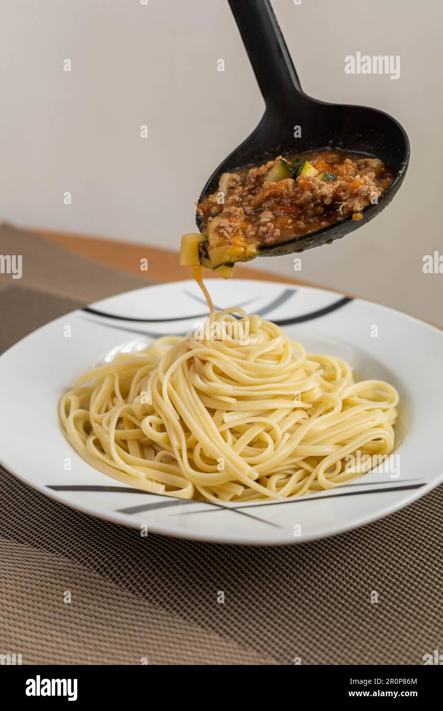 Italian food, plate with spaghetti and meat as a side dish, delicious ...