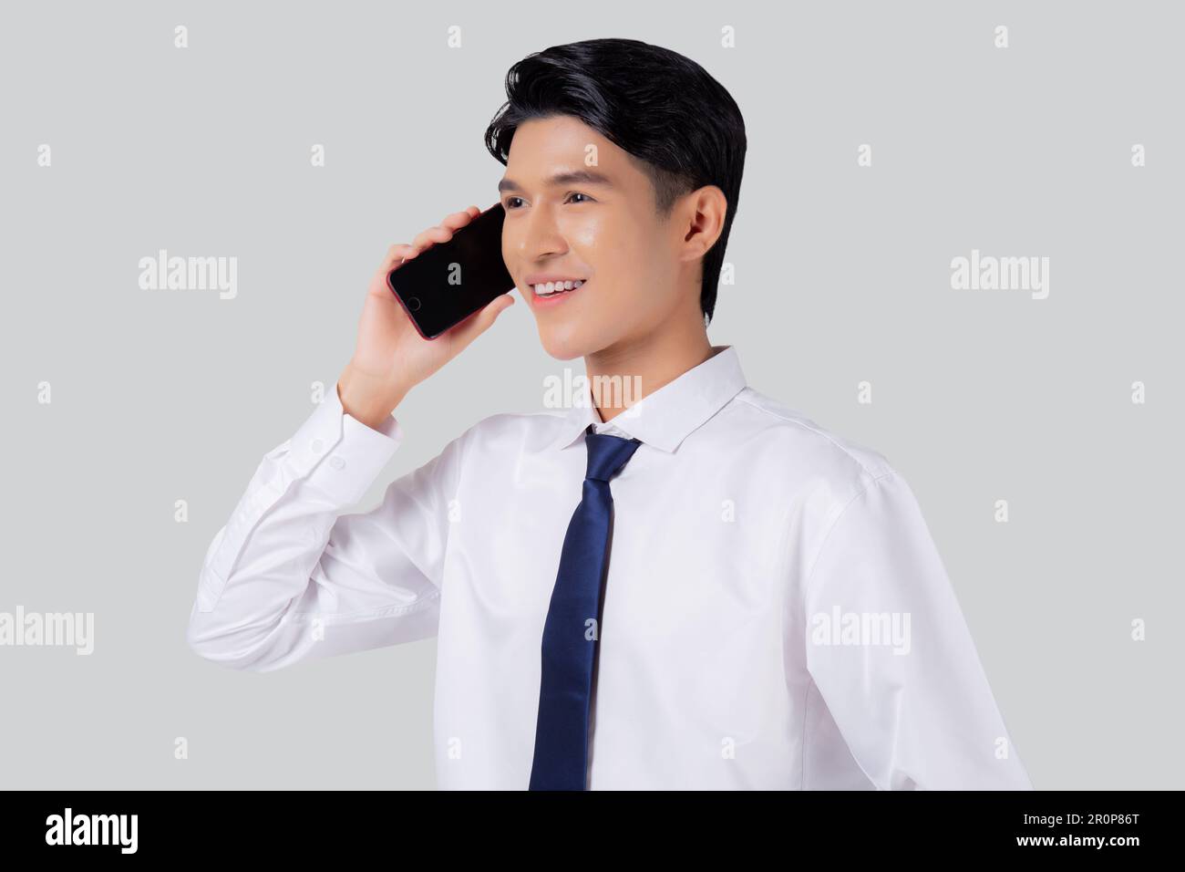Portrait young asian businessman using smartphone talking isolated on ...