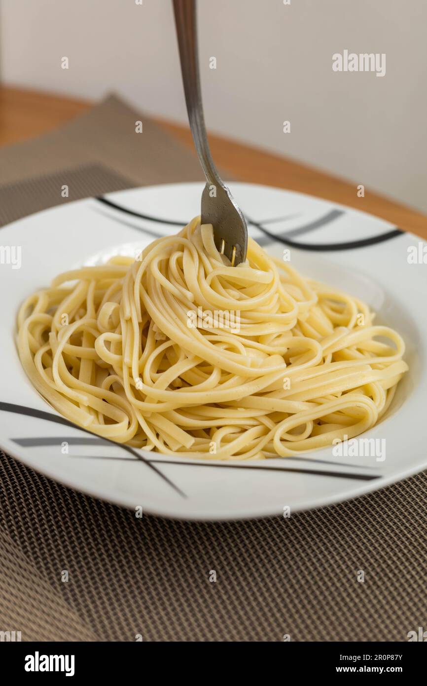 homemade food plate of spaghetti with a fork, decoration and domestic ...