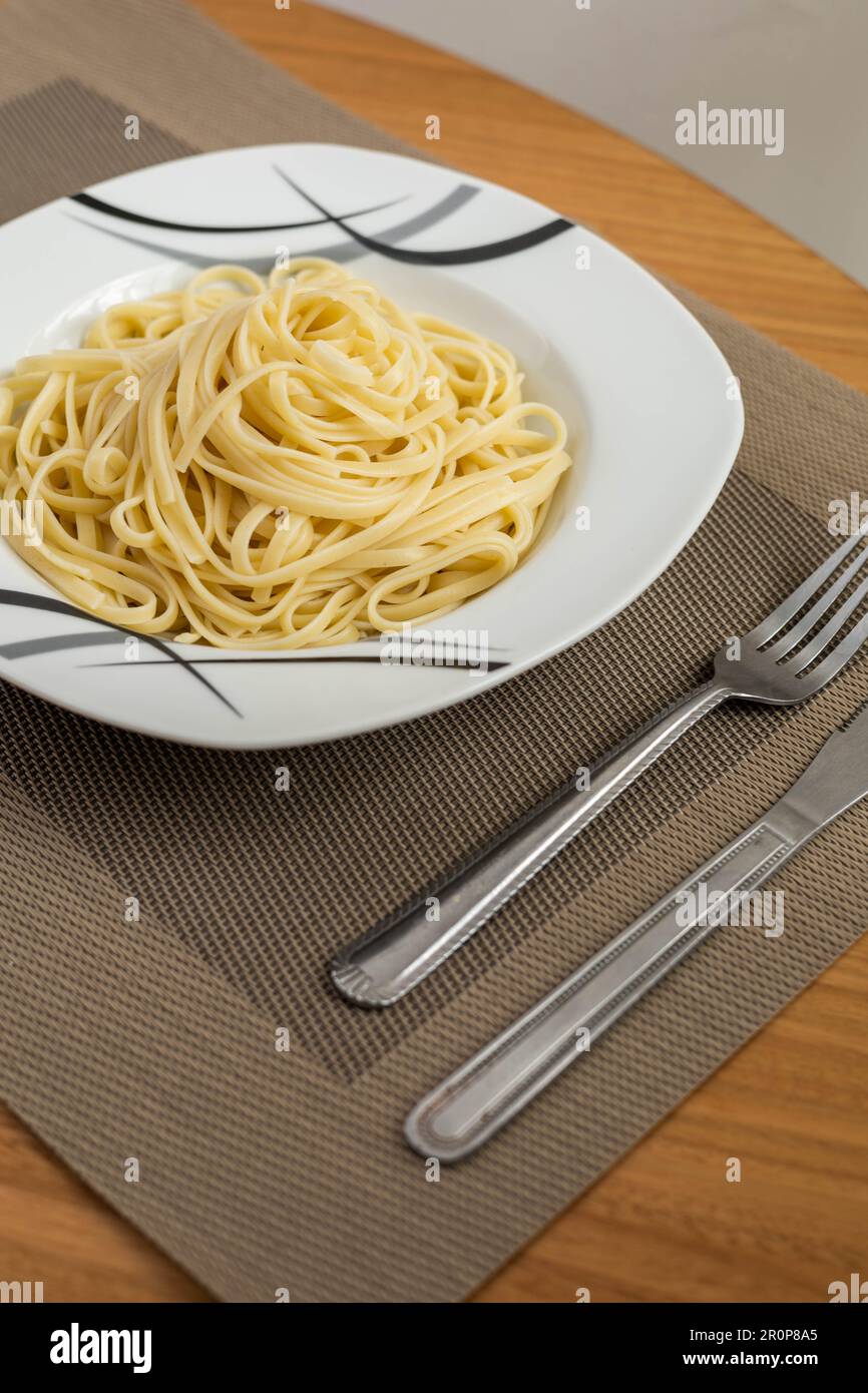 table setting served, homemade food plate of spaghetti with a fork ...