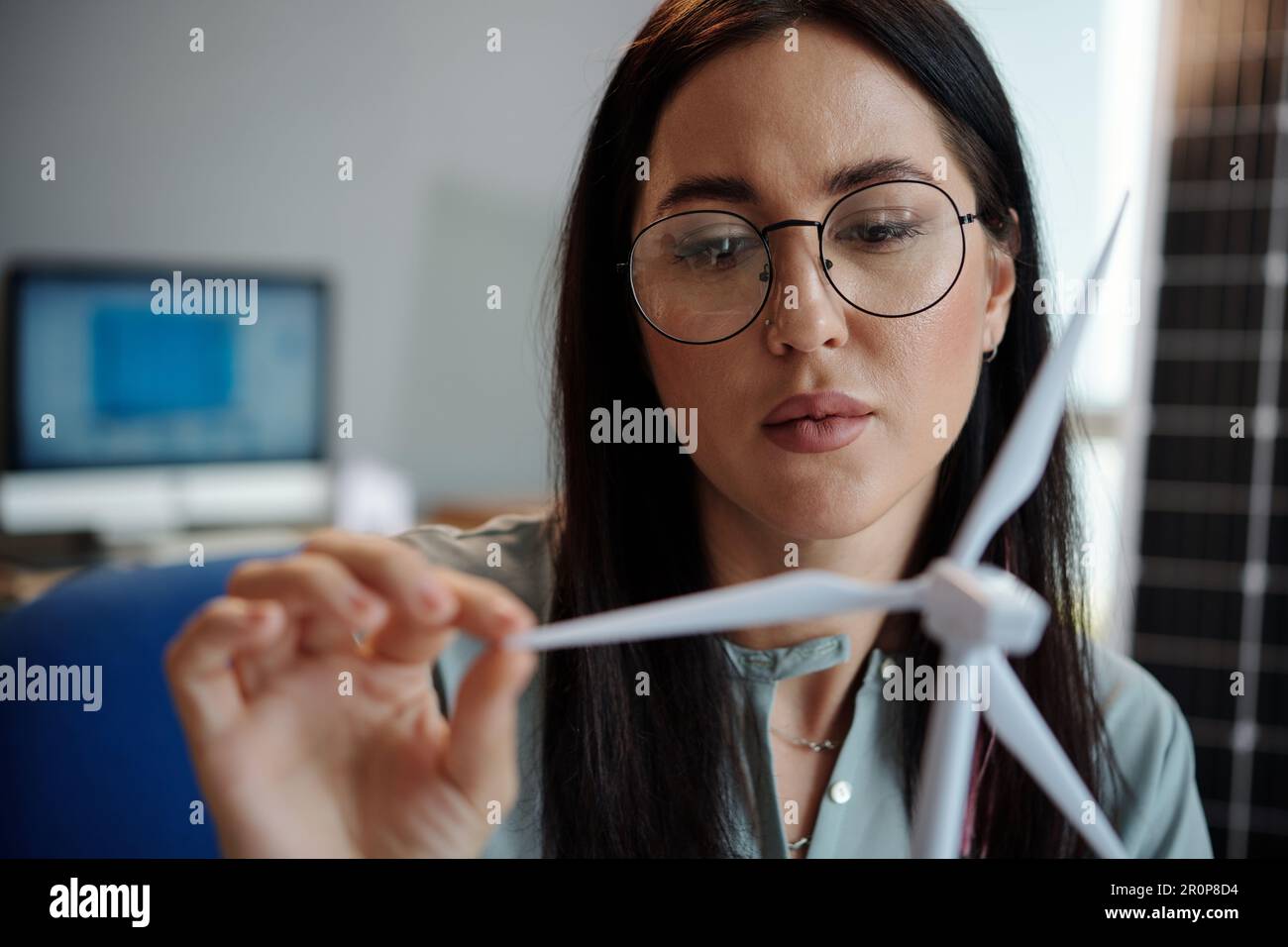 Female wind turbine engineer checking how plastic model she created ...