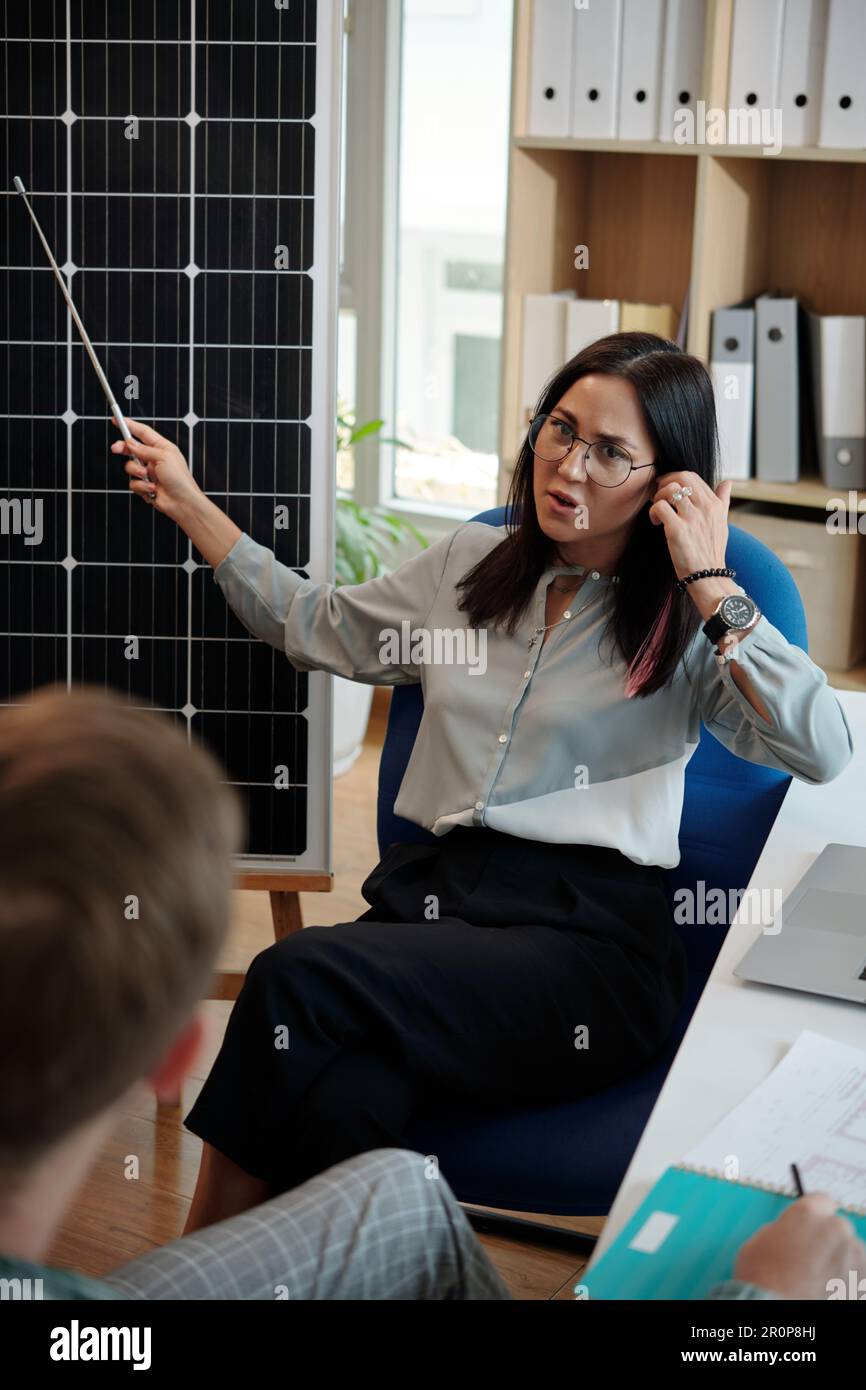 Manager pointing at solar panel when explaining principle of work to ...