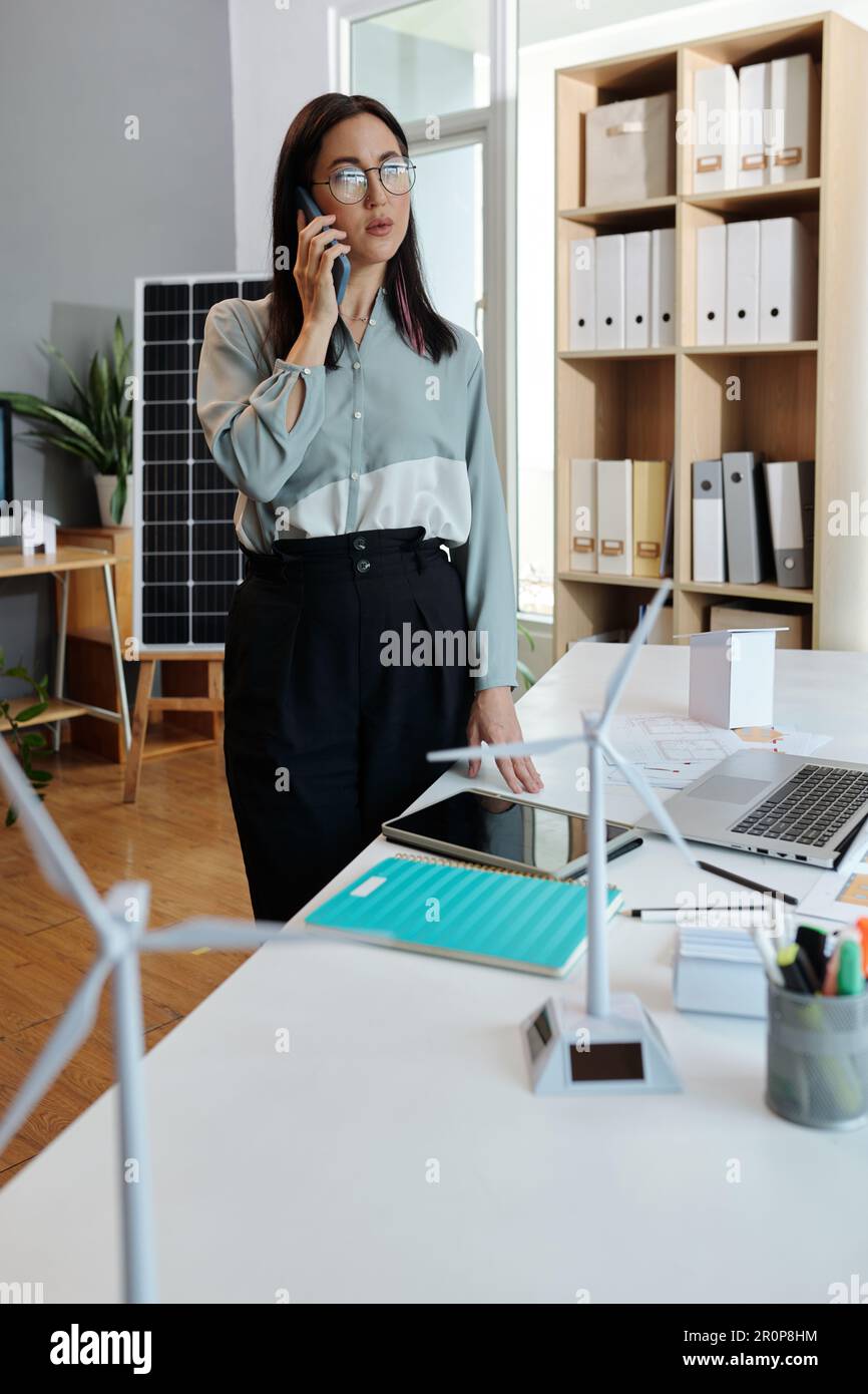 Sustainable energy company manager talking on phone with potential ...