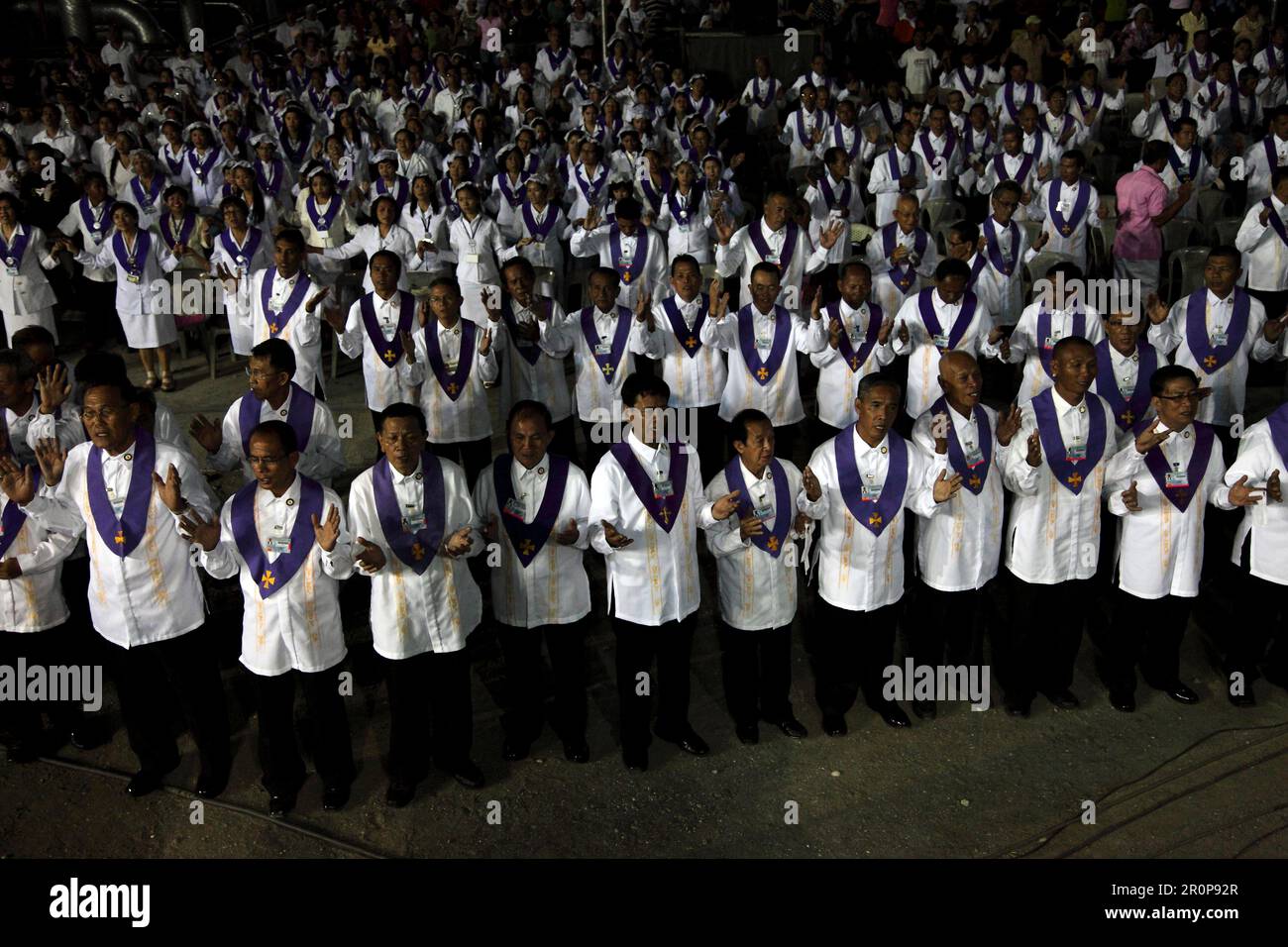 Members of El Shaddai clad in white, participating in the mass ...