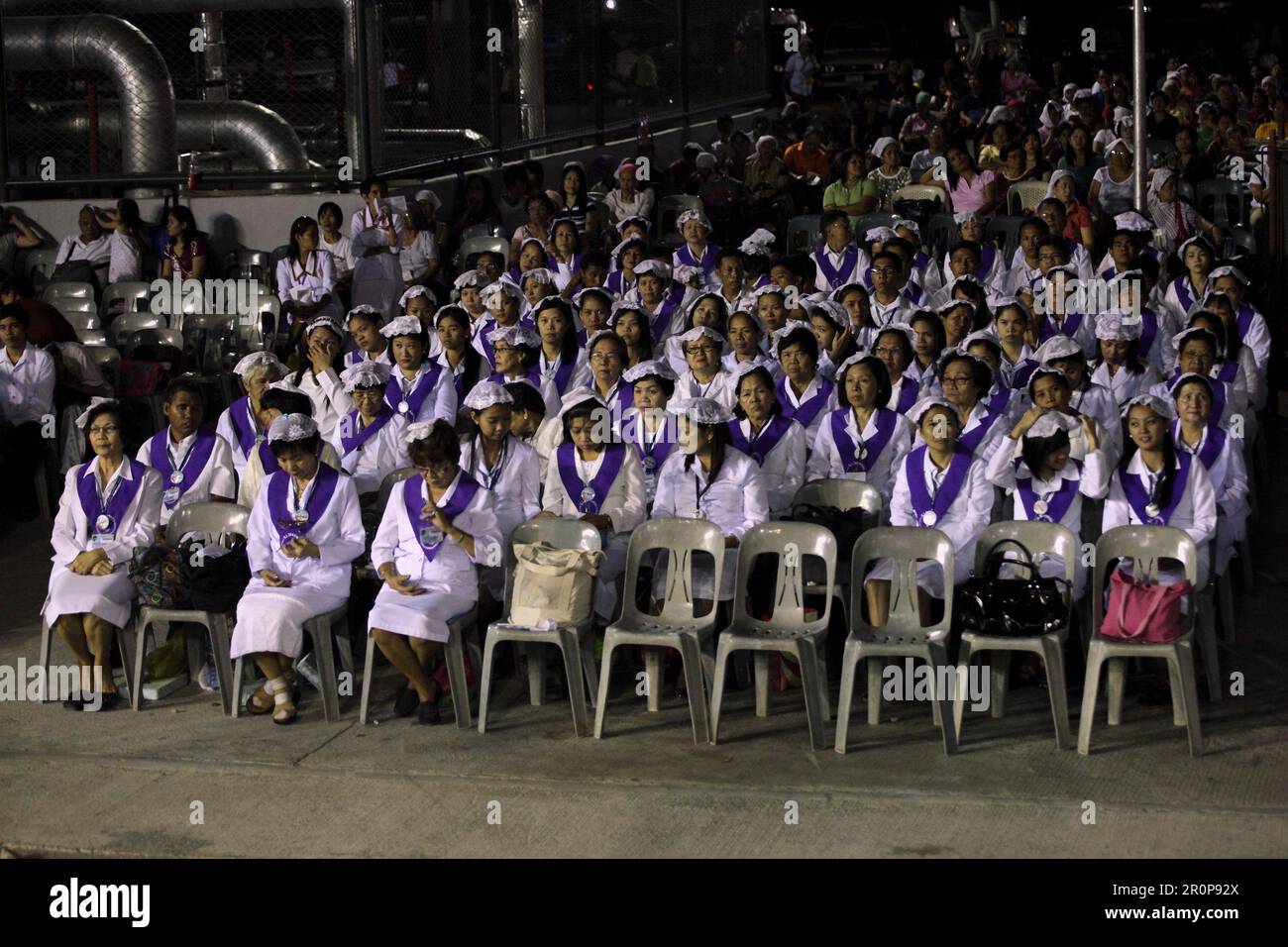 Members of El Shaddai clad in white, participating in the mass ...