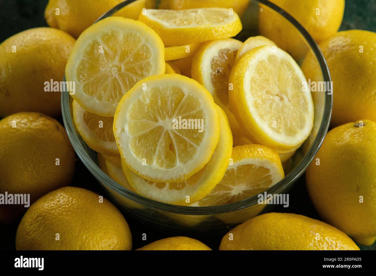 whole and sliced lemons arranged in a circular pattern on a green ...