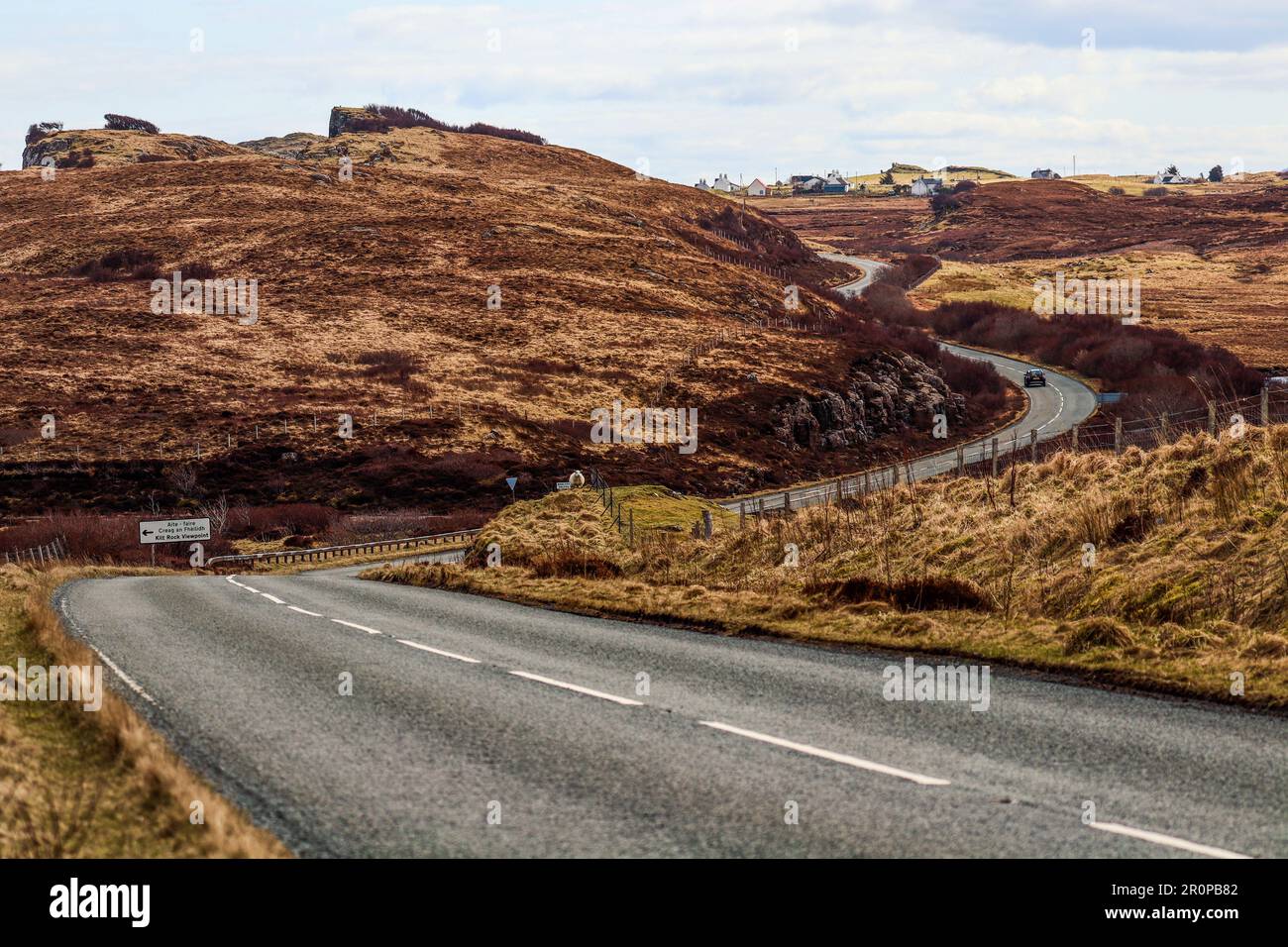 A meandering asphalt road traversing the arid brown hills of the Isle ...