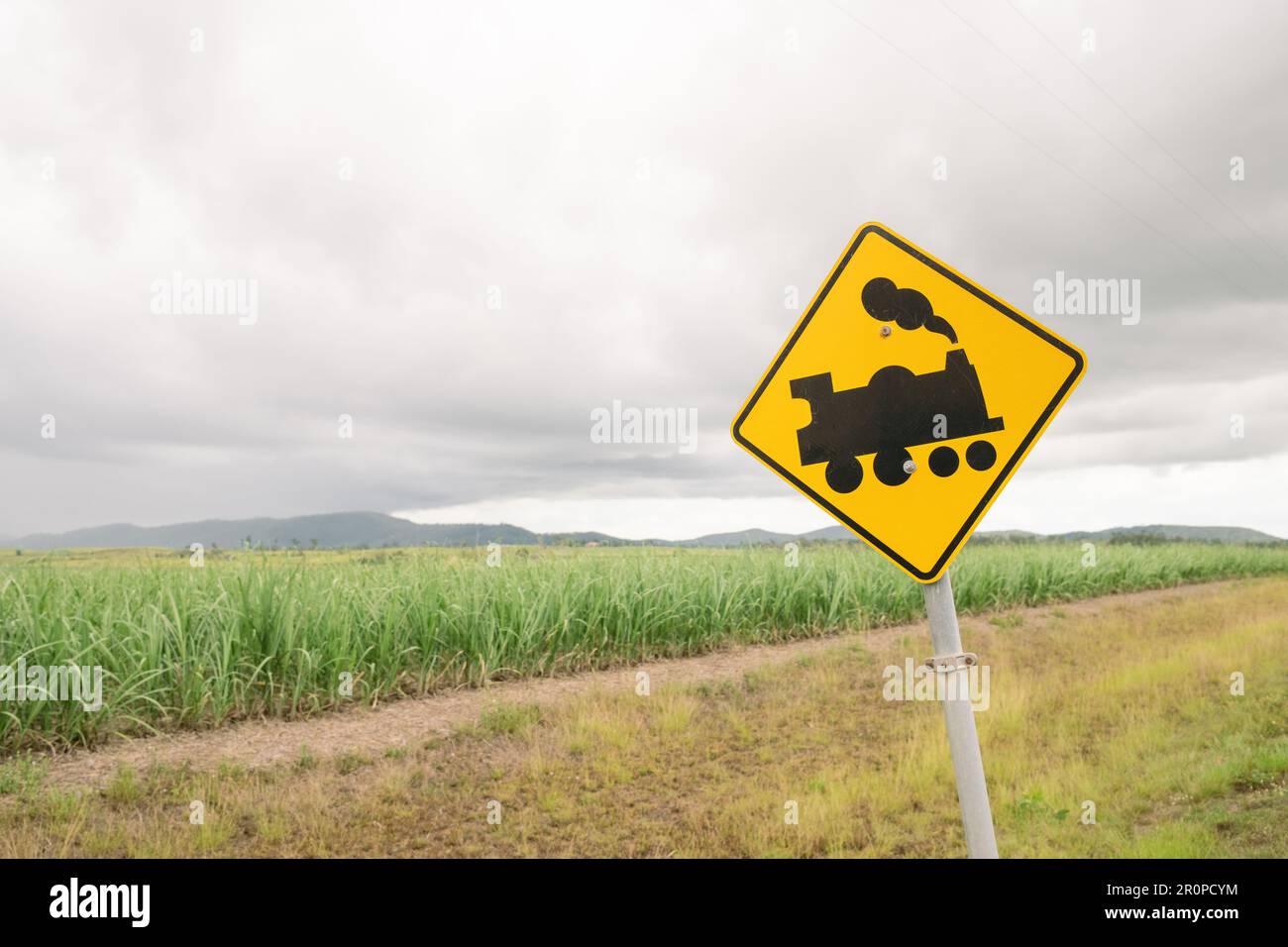An isolated road sign depicting a road train against a backdrop of a ...